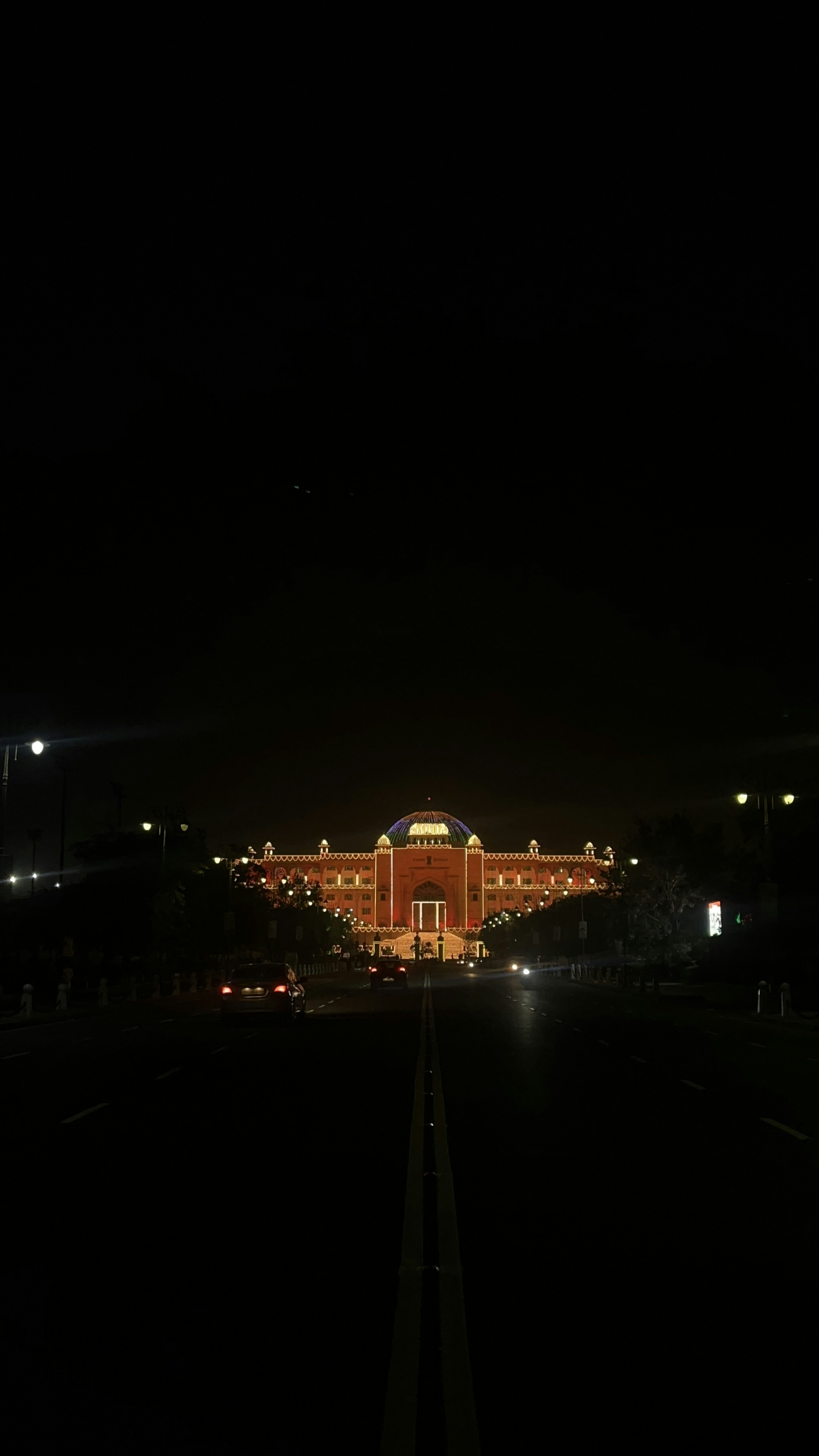 a large building lit up at night in the dark