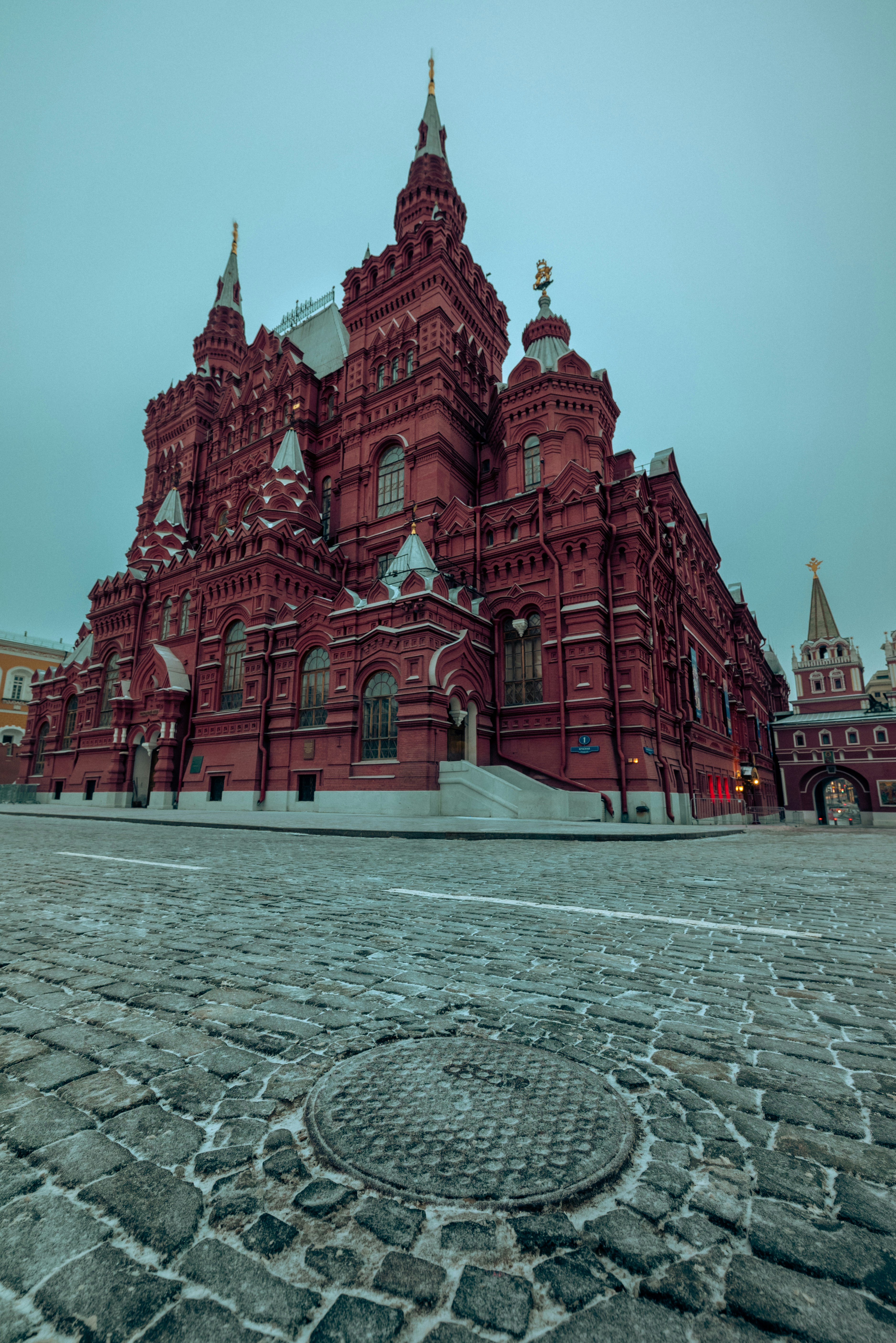 A large red building with a clock tower on top of it photo – Free ...