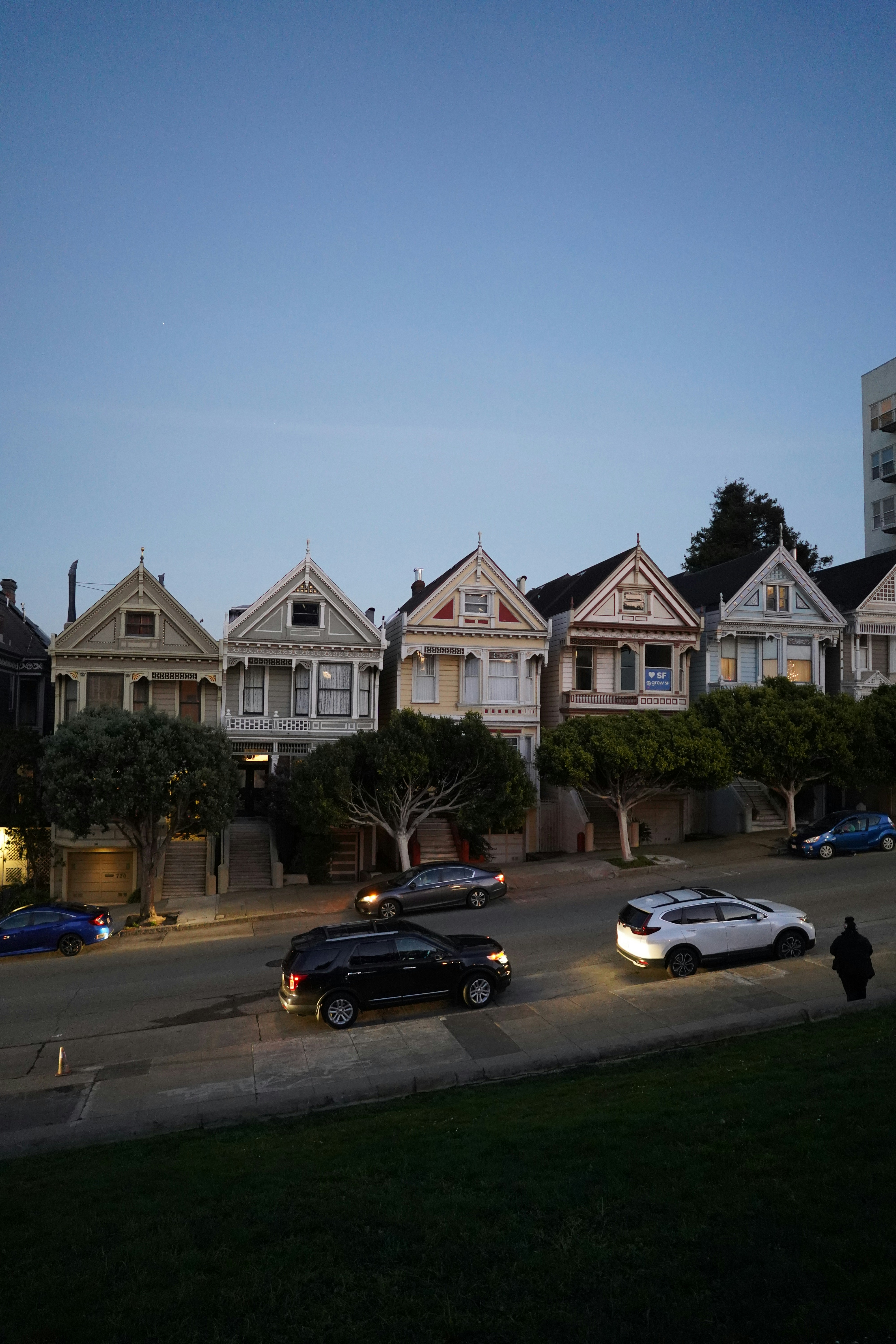 Row of Painted Victorian Townhouses under Golden Hour Sky