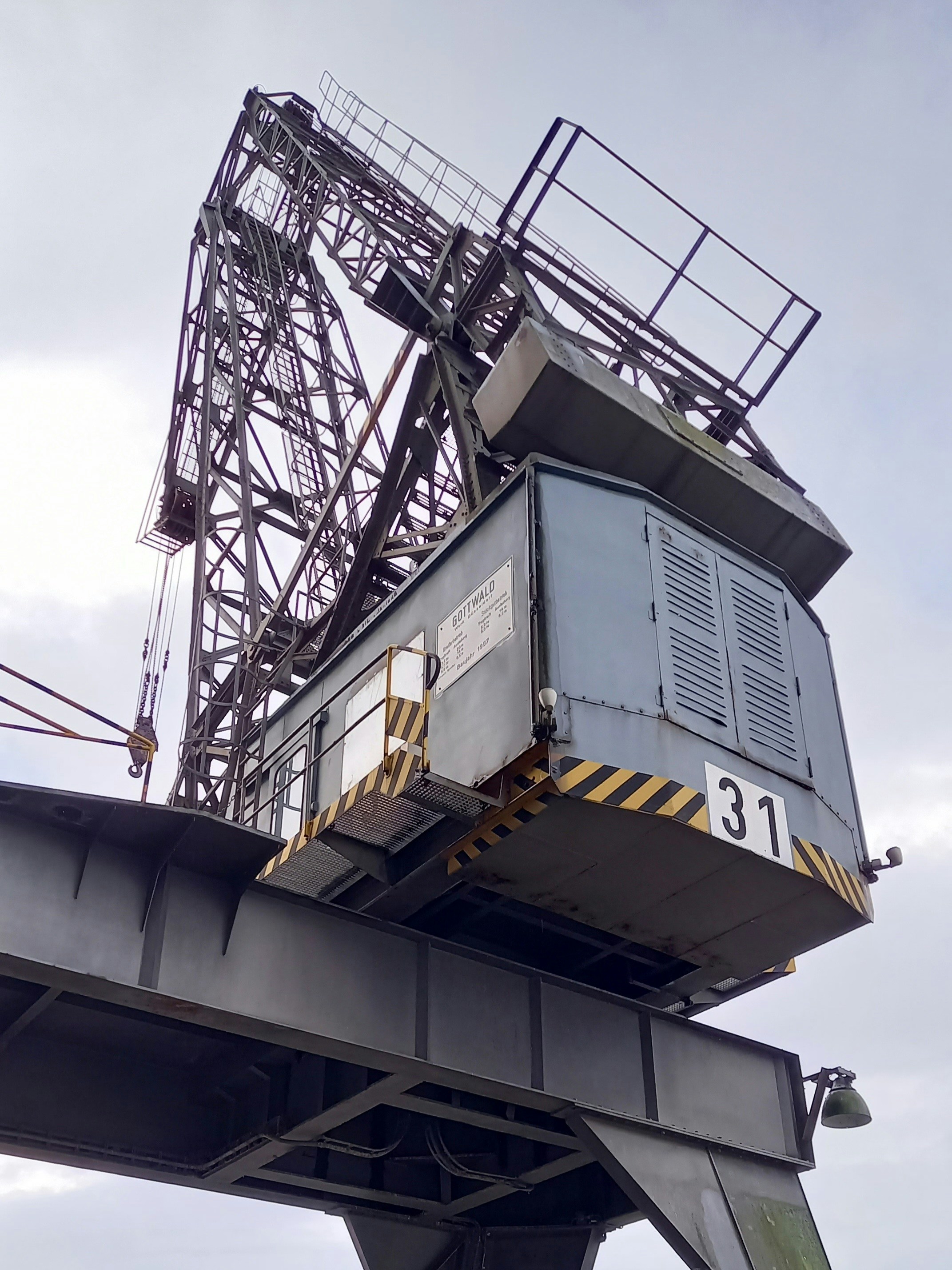 Crane Crown: Weathered Lattice Over a Steel Span