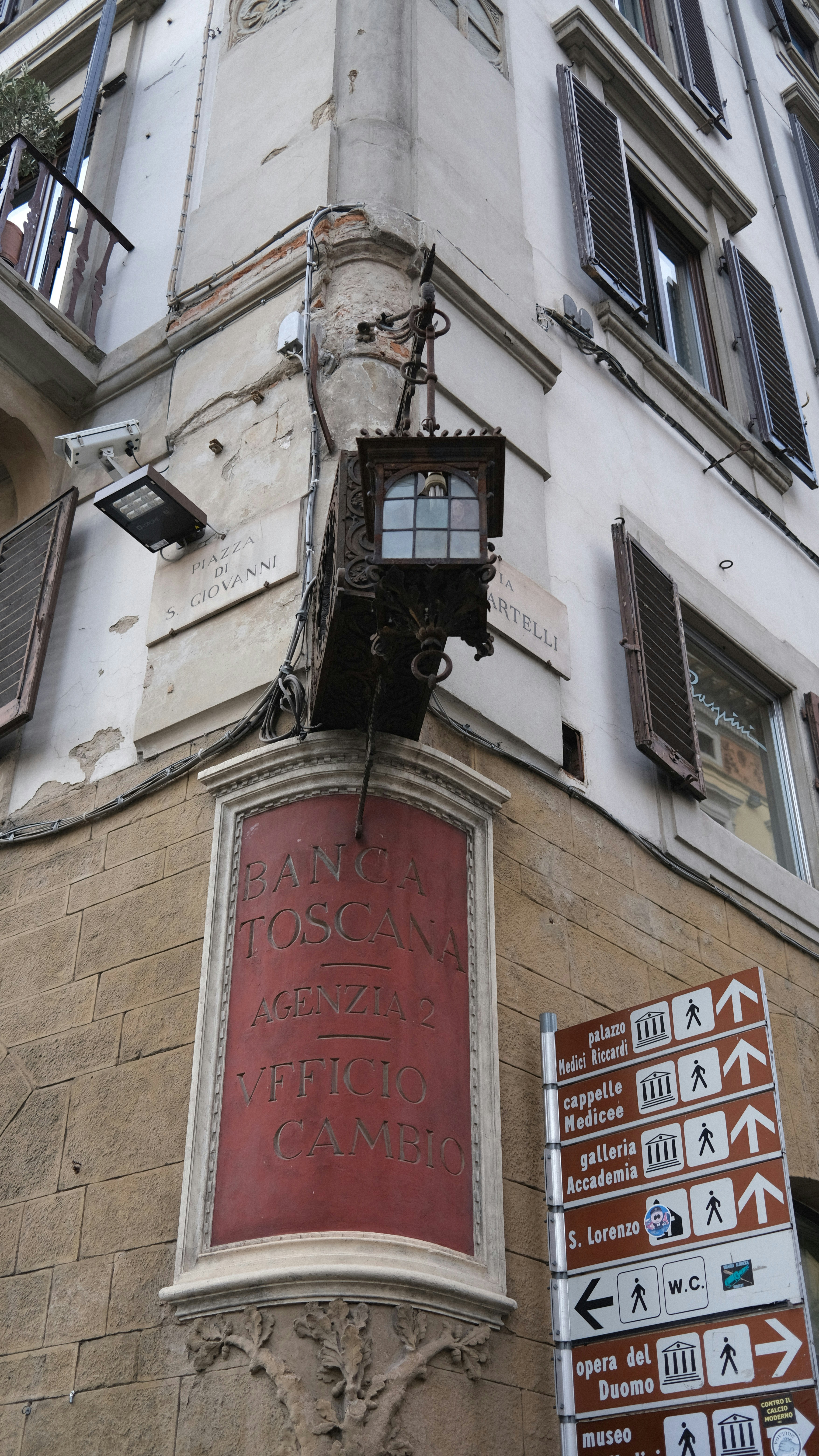 Lantern and Red Plaque: A Tuscan Street Corner in Focus