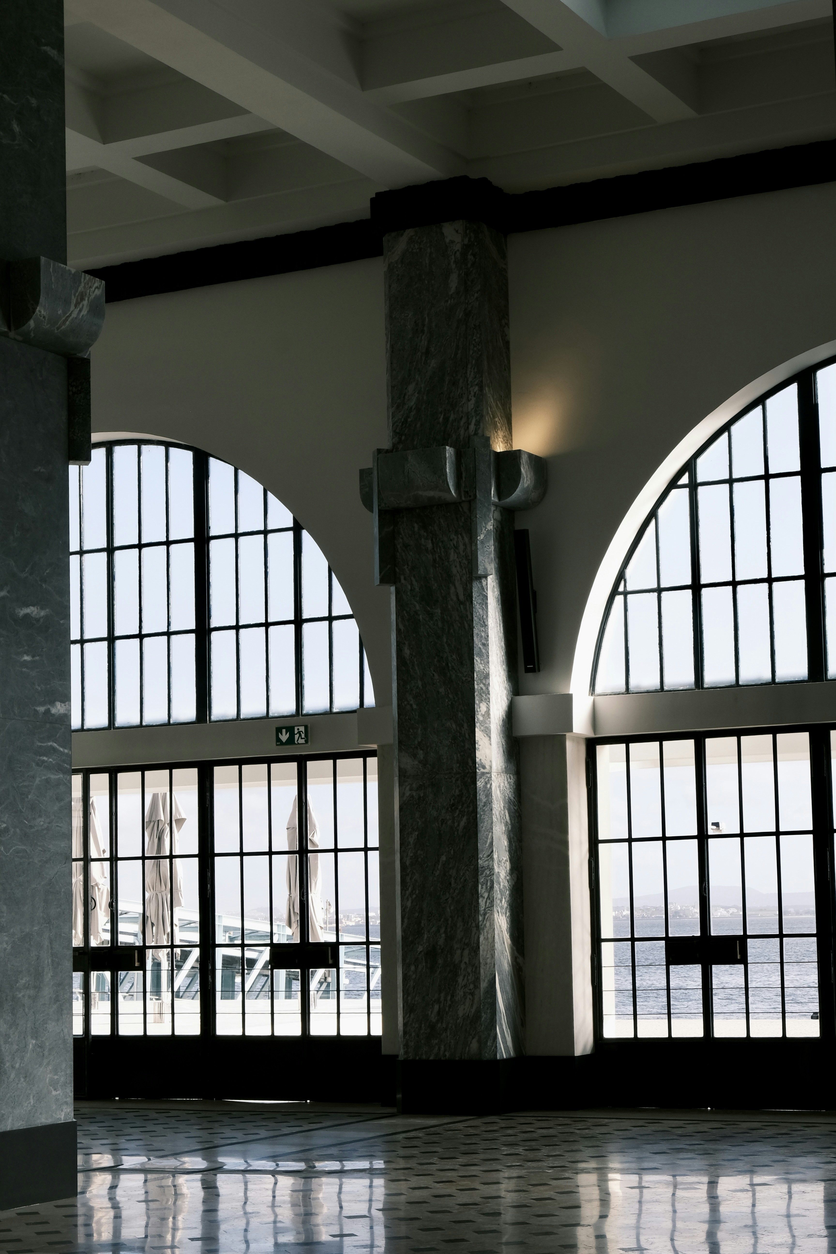 Harbor Light Through Arched Windows Framing Marble Pillars in a Quiet Atrium