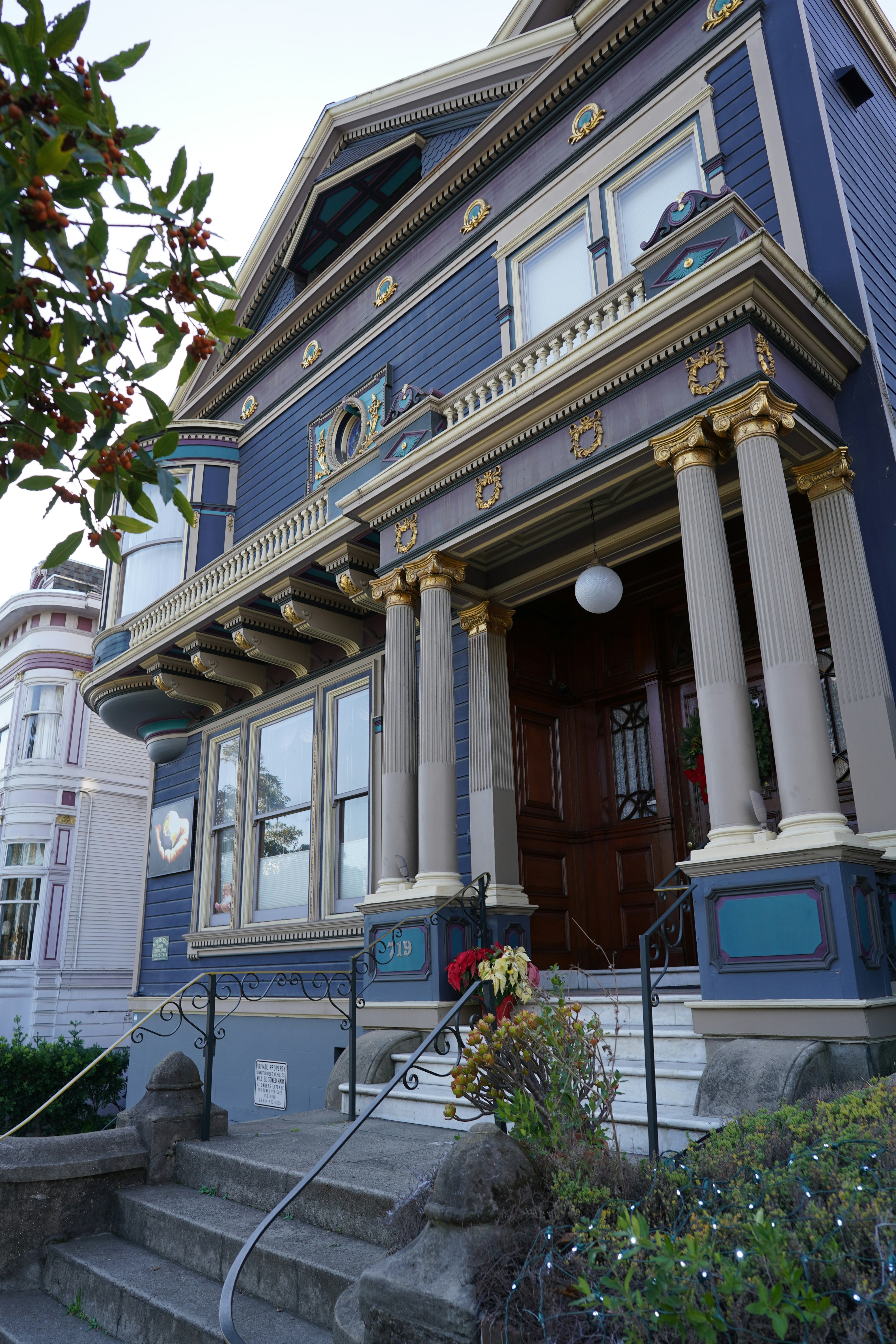 A large blue house with columns on the front of it photo – Free ...