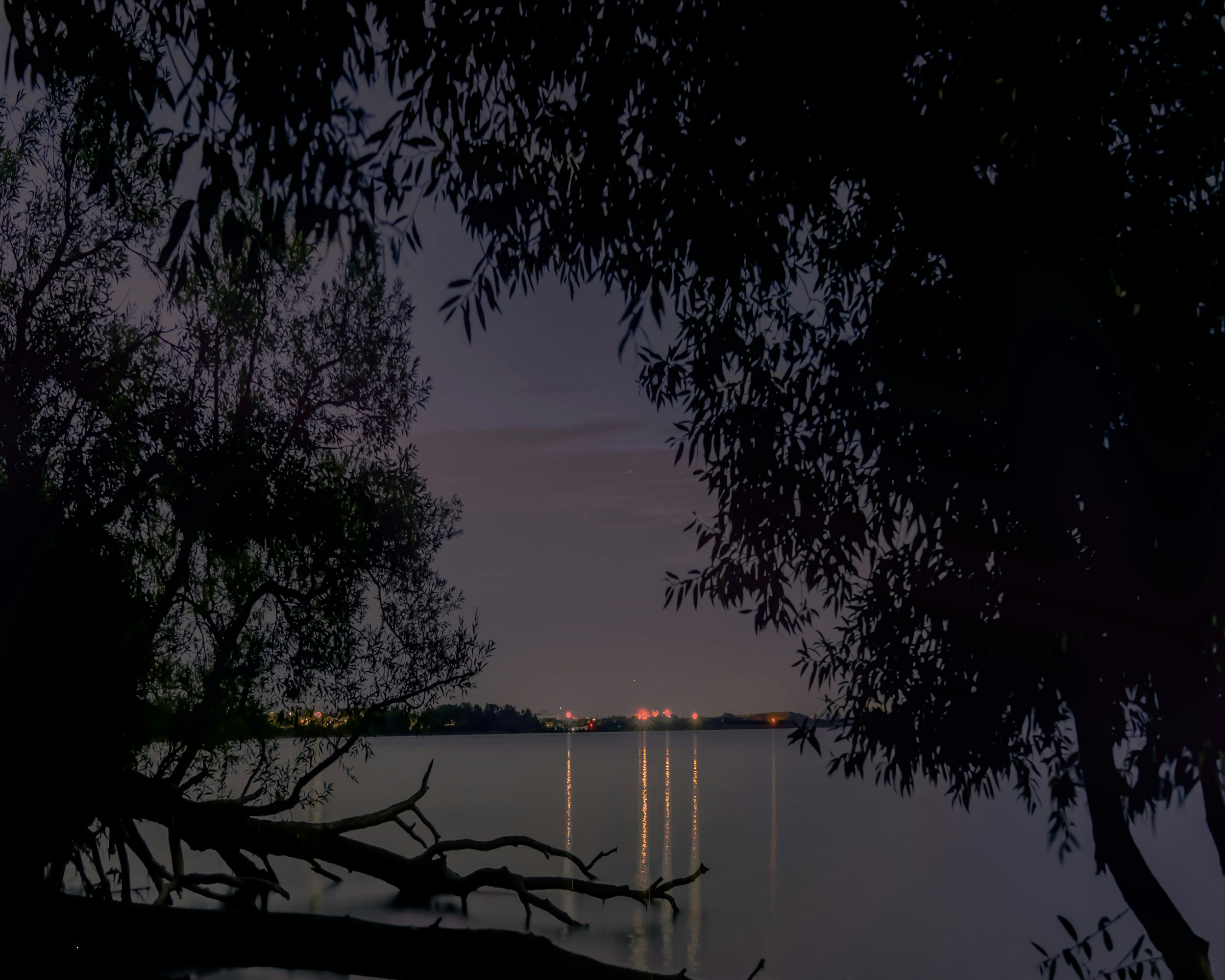 Horizon Lanterns Over a Quiet Lake: Night Silhouettes Framing Distant Lights