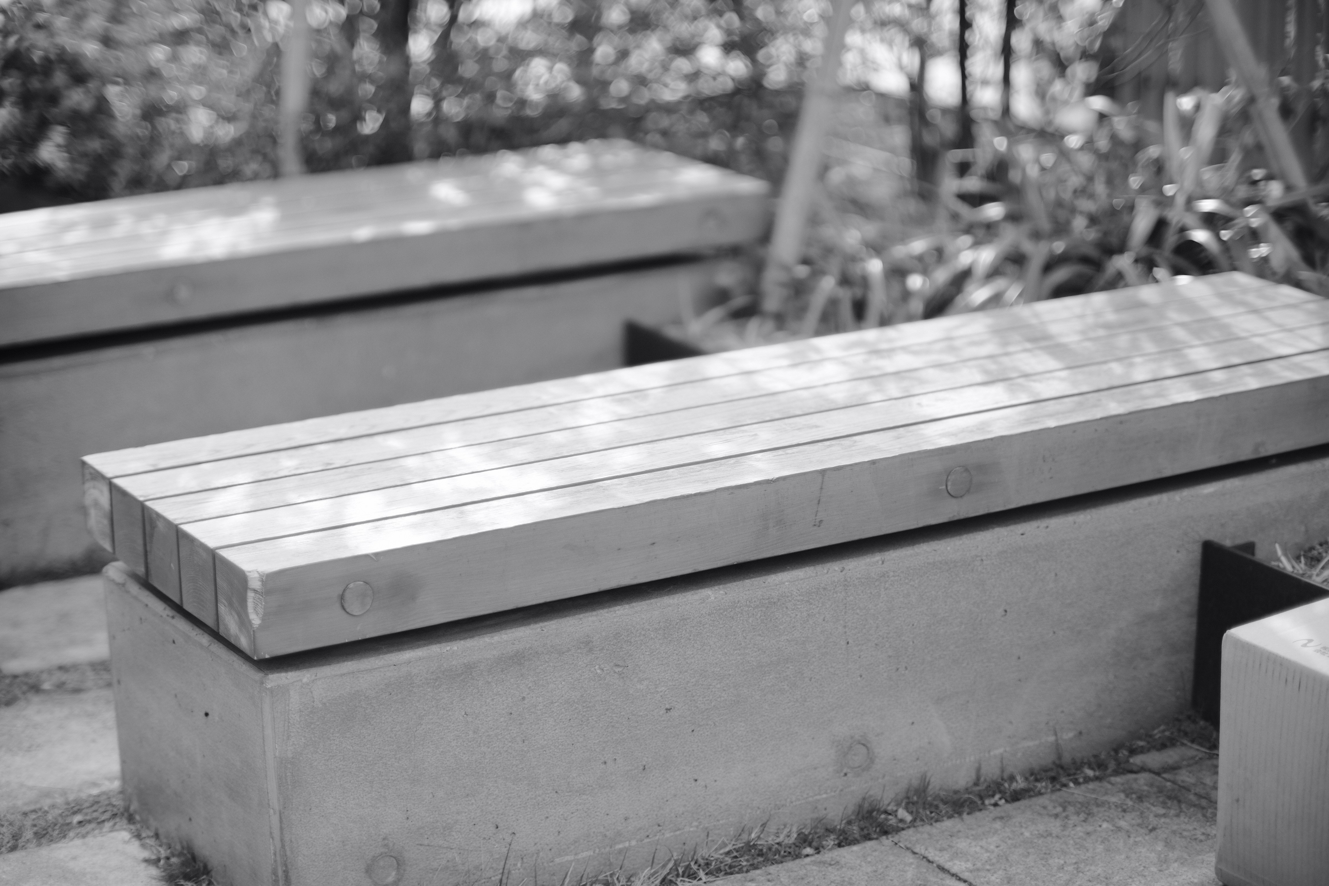a black and white photo of a wooden bench