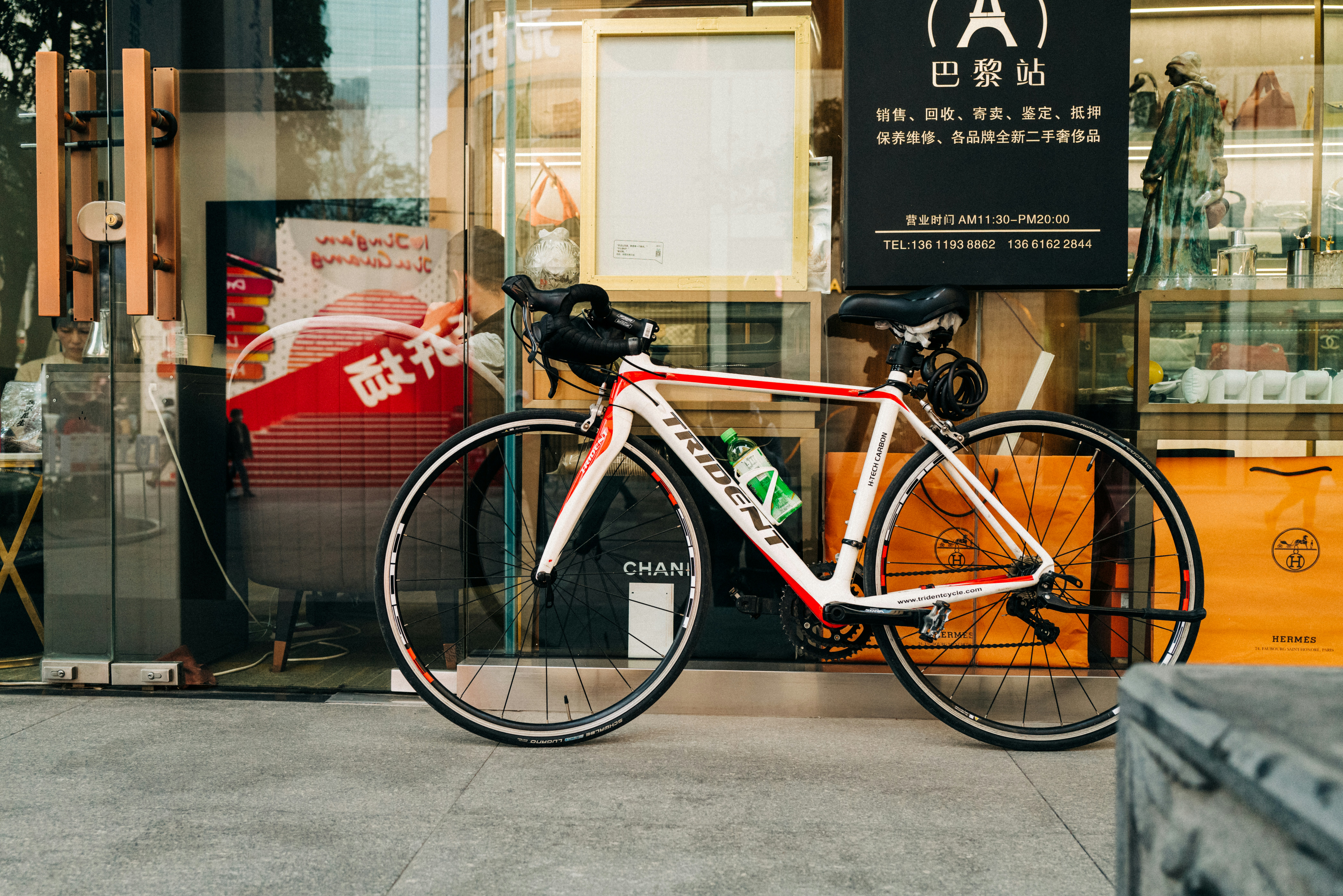 Urban Red-and-White Road Bike Anchored by a Shore of Glass
