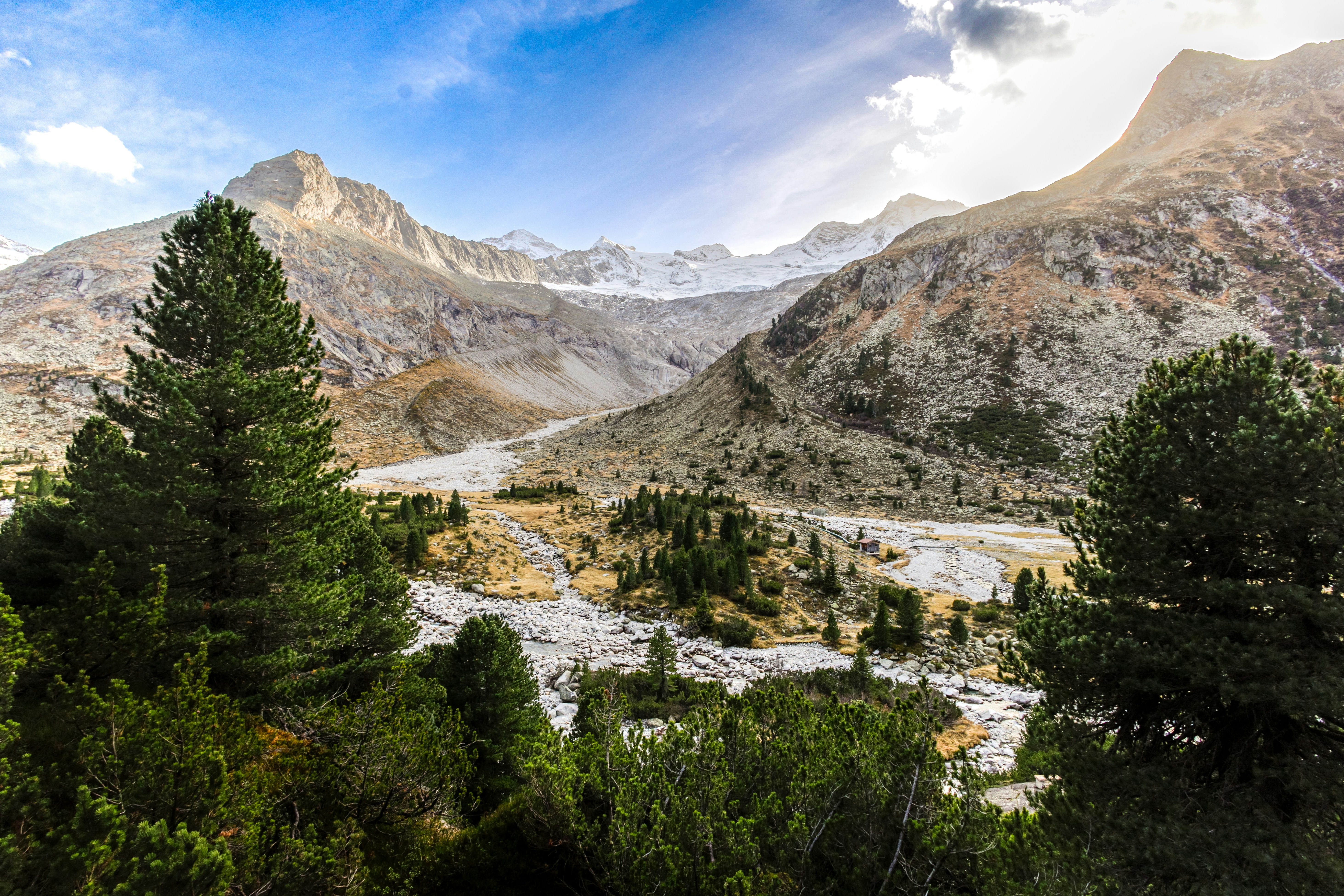 A view of a valley with mountains in the background photo – Free ...