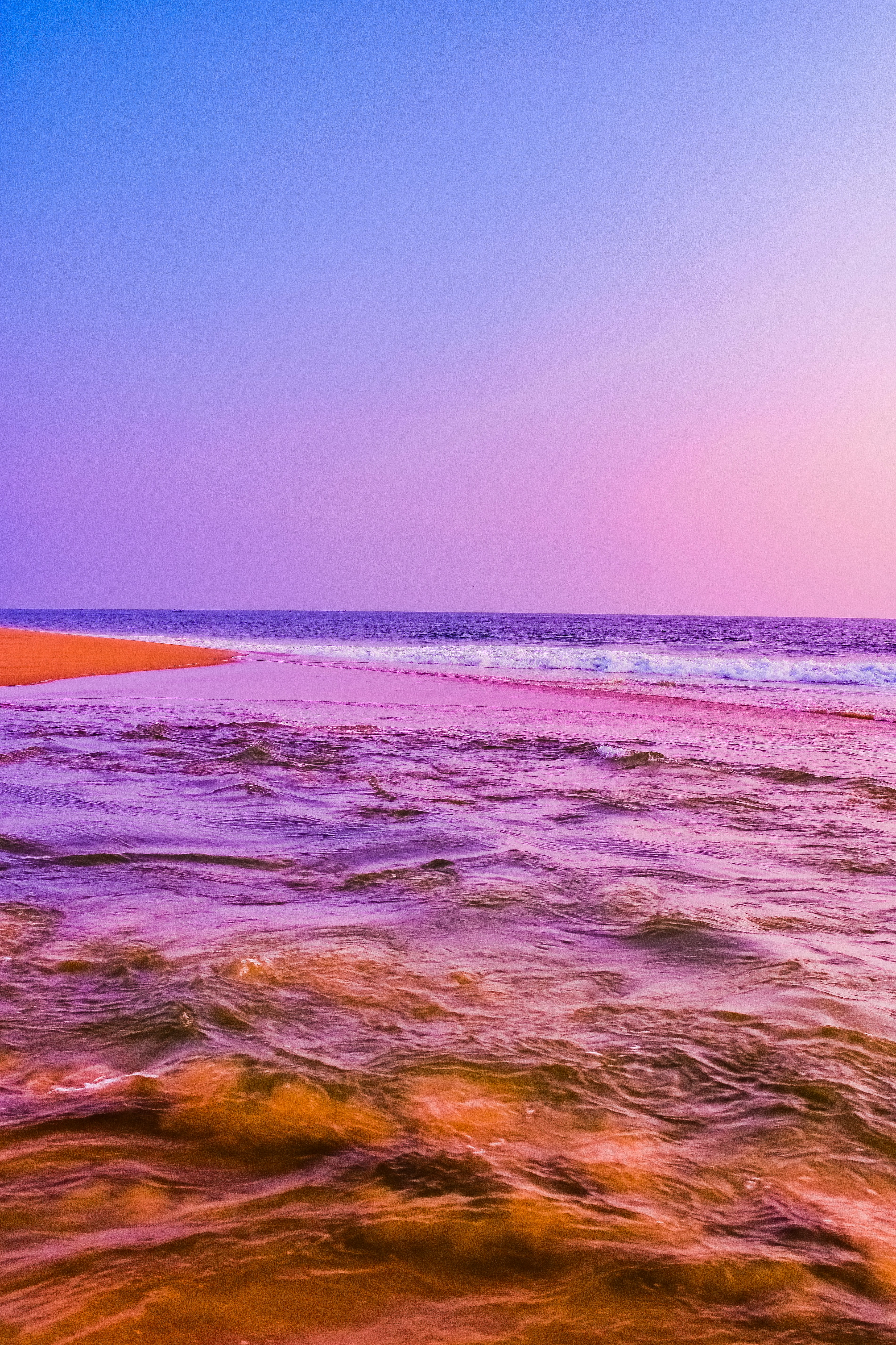 Twin Horizons: Sunset-Hued Tide rolling toward Pink Sands