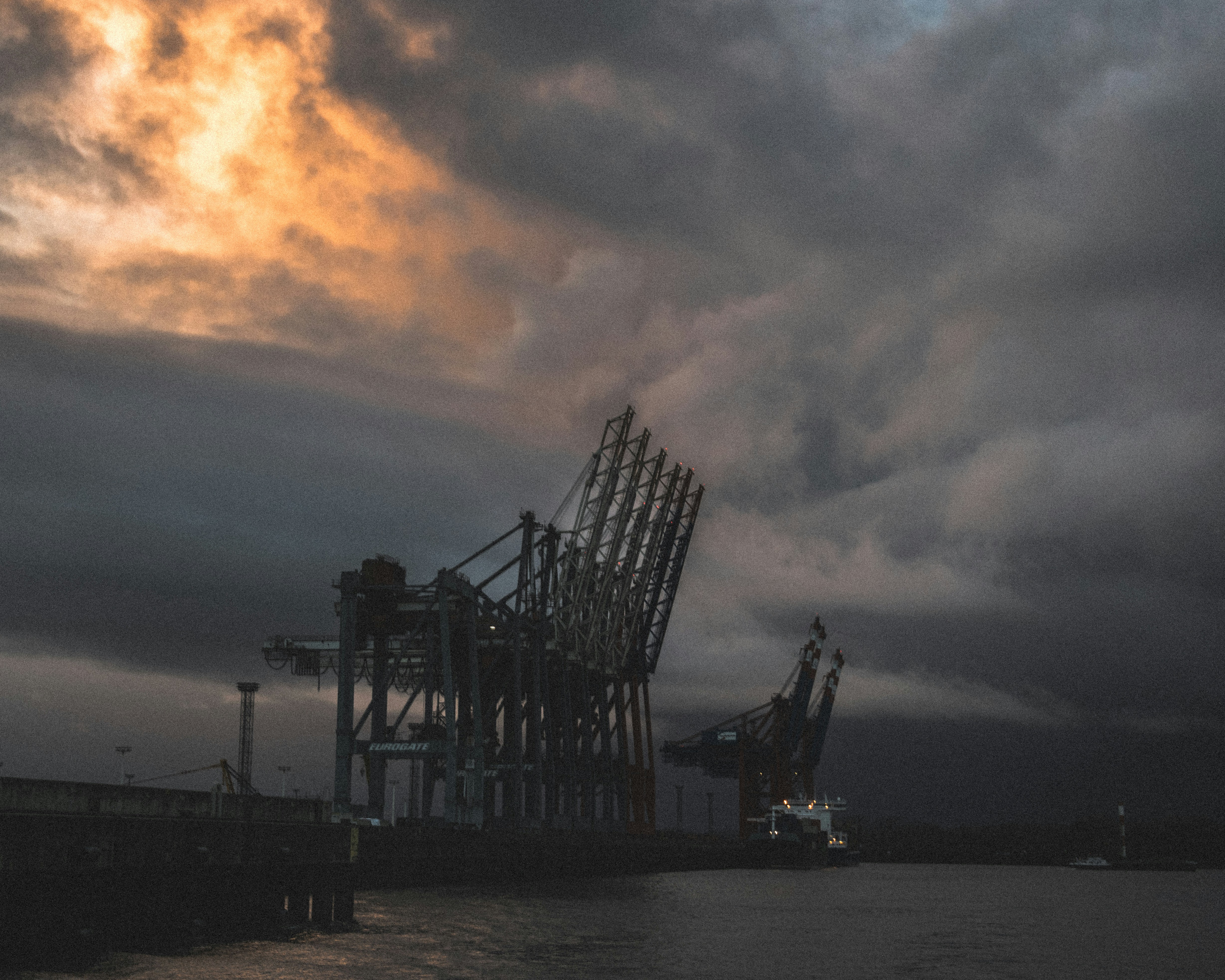 Industrial Giants at Dusk: A Harbor Crane Scene