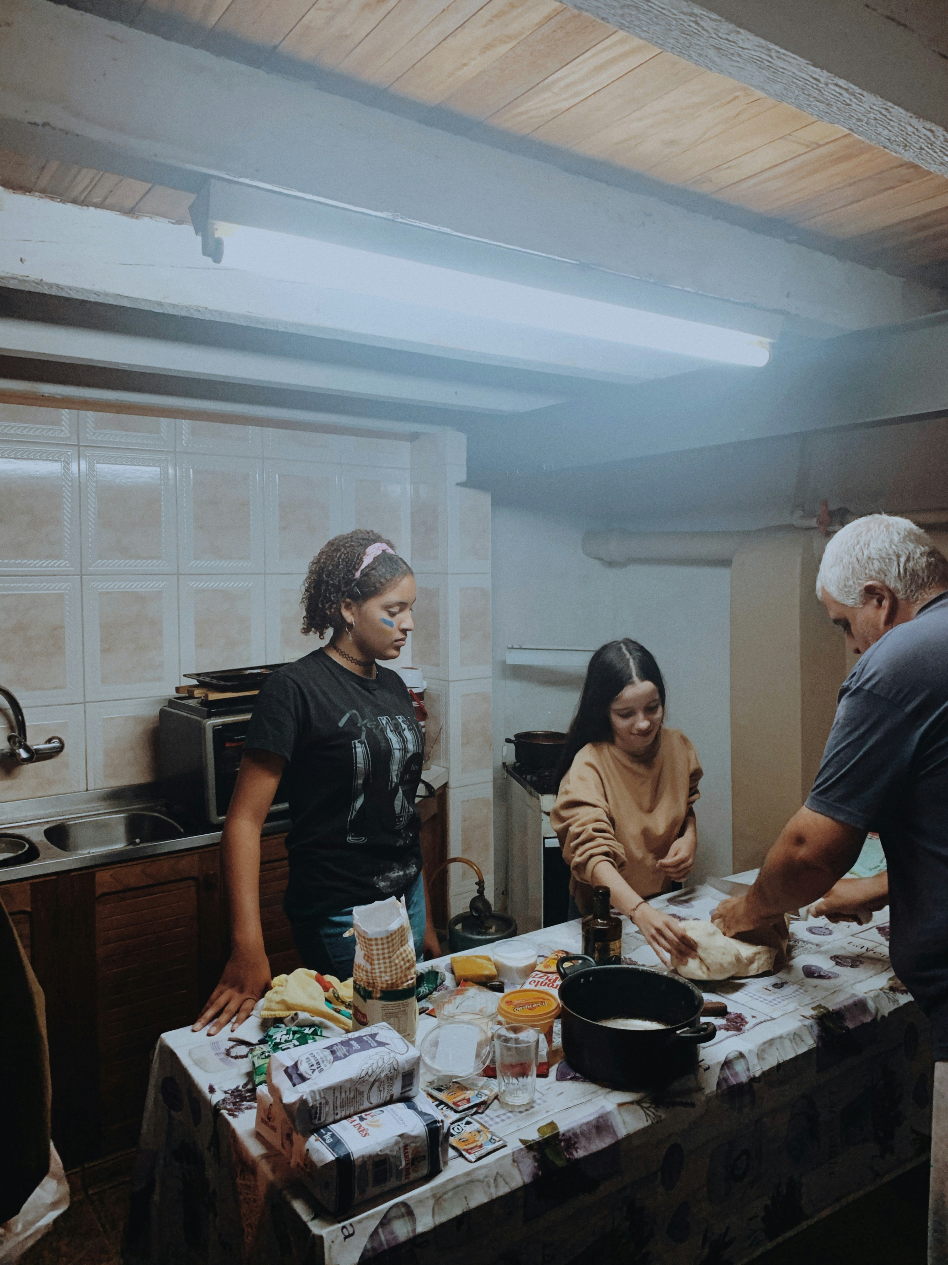 A group of people preparing food in a kitchen photo – Free Image on ...