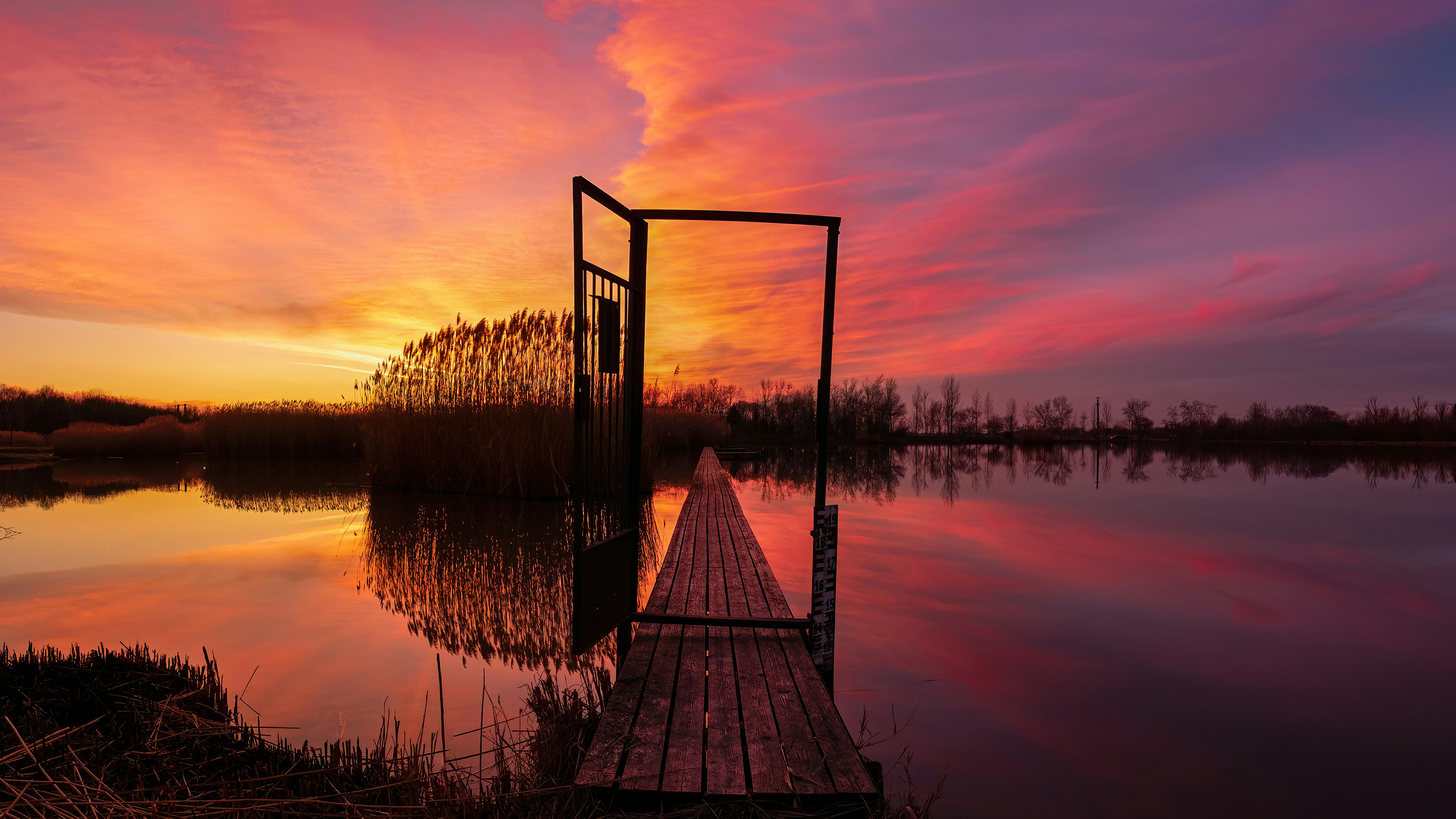 End-Frame at Dusk: A Pier Reaches Toward Reflective Skies