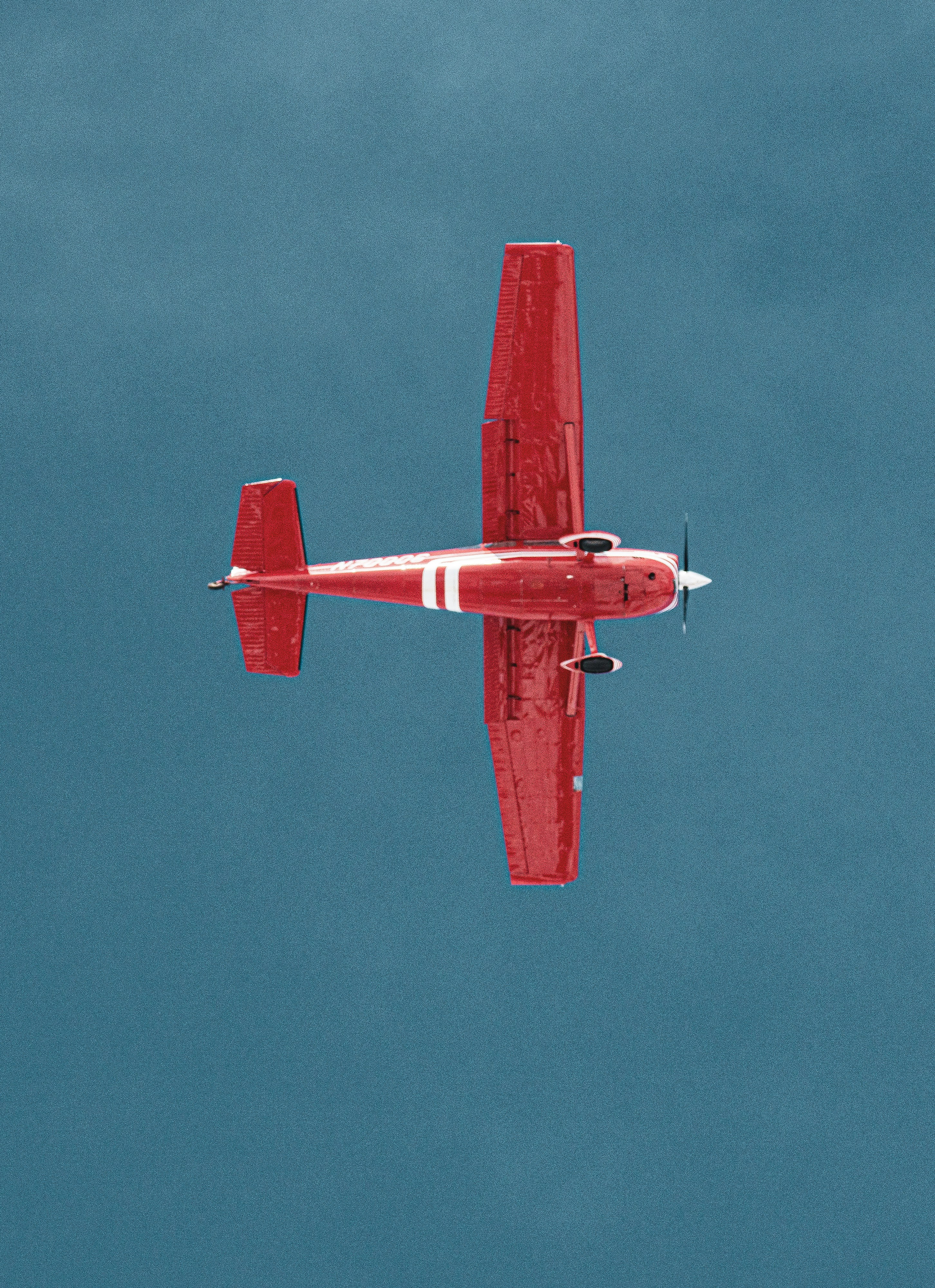 A small red airplane flying through a blue sky photo – Free Bird Image ...