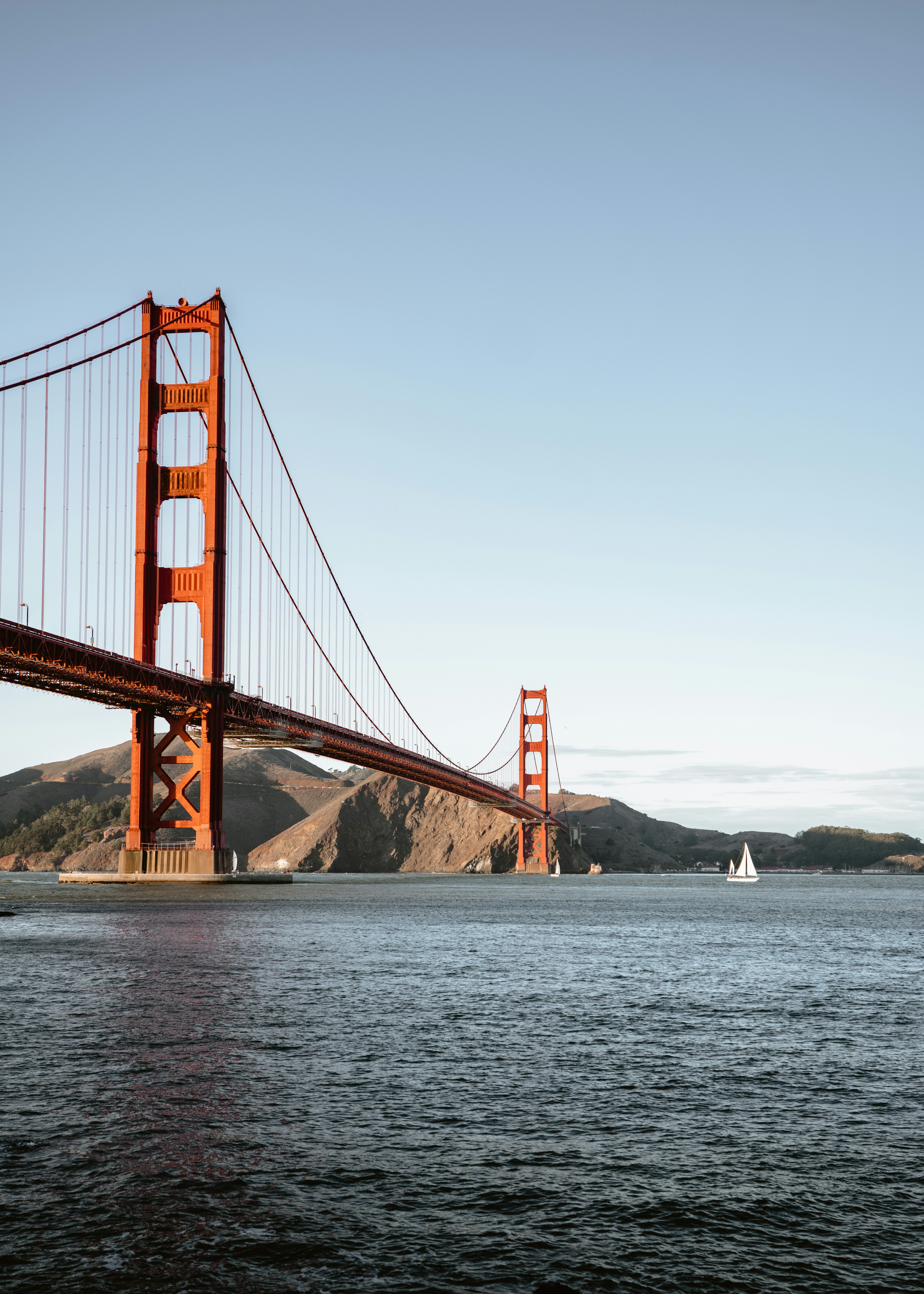A large bridge spanning over a large body of water photo – Free Golden ...