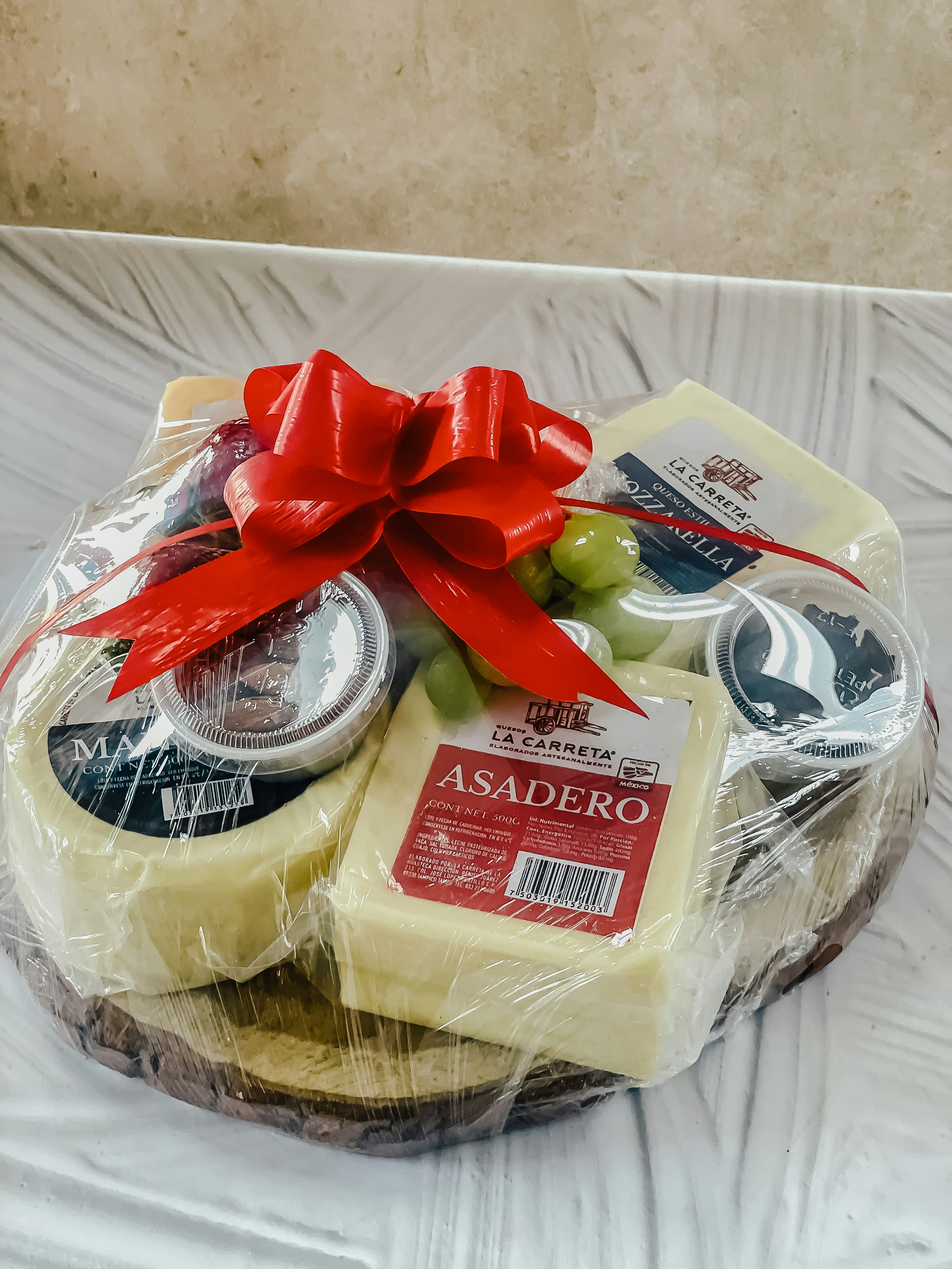 A basket of cheese with a red bow on top of it photo – Free Food Image ...