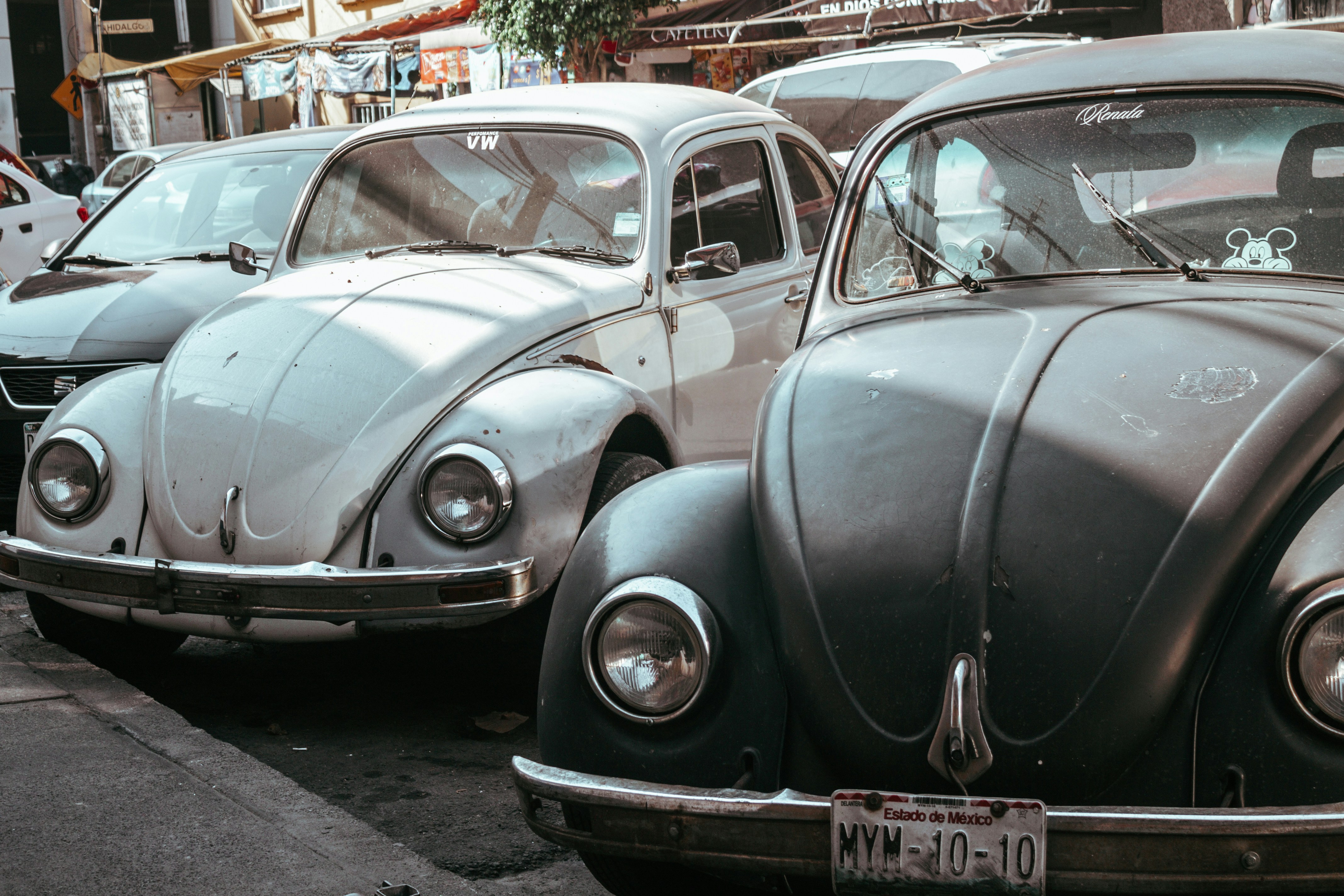 Vintage Volkswagen Parade: Weathered Karmann Ghias Resting in the Alley