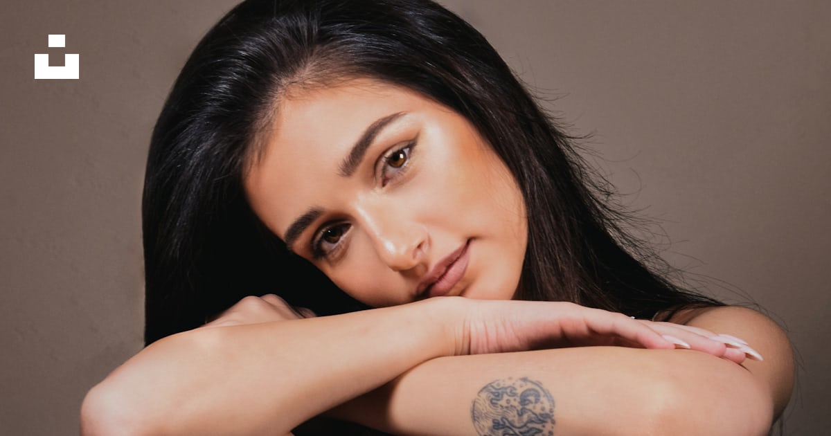A Woman With A Tattoo On Her Arm Photo Free Portrait Image On Unsplash