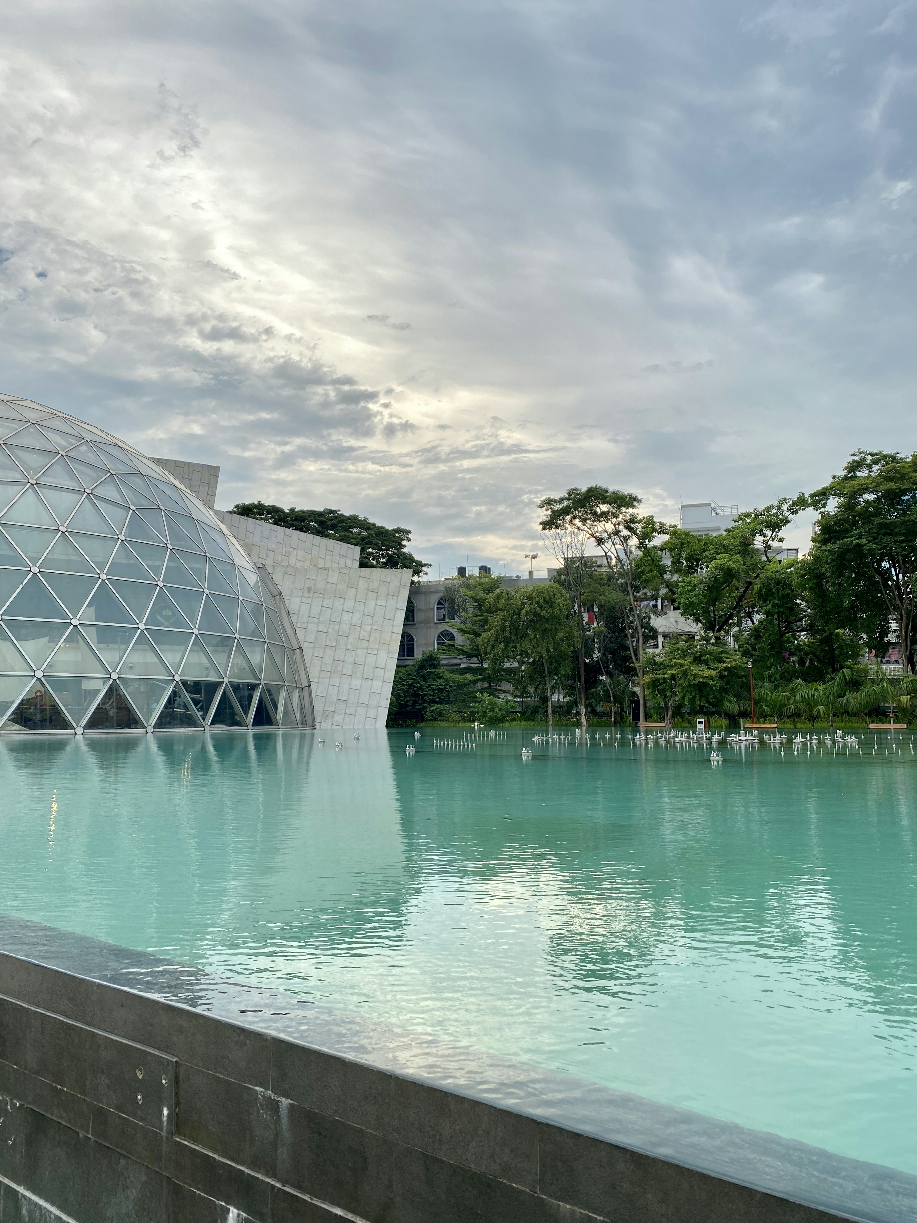 Geometric Glass Dome by a Teal Mirror Lake
