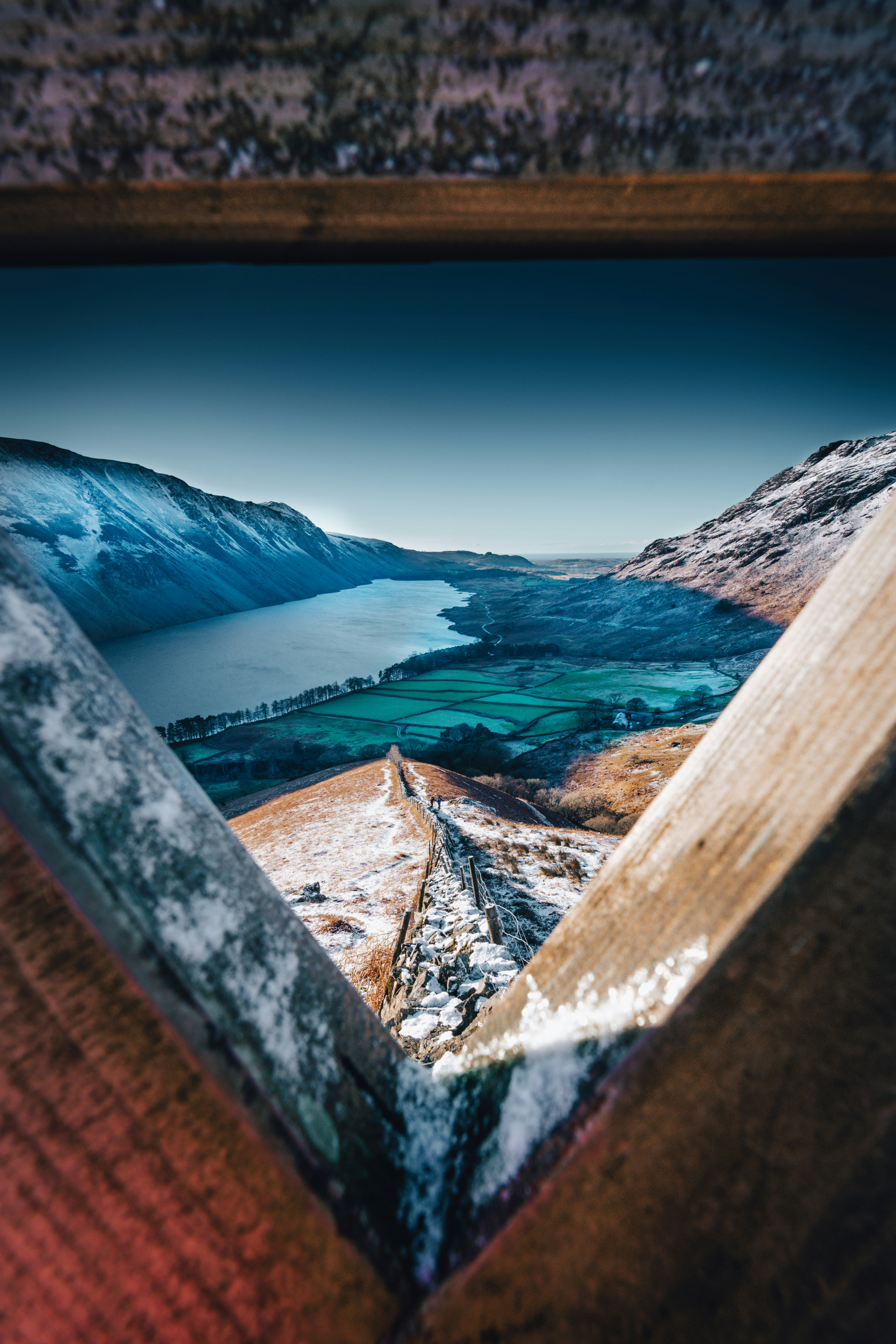 View Through a Timber Frame: A Mountain Pass Framed by Angled Beams
