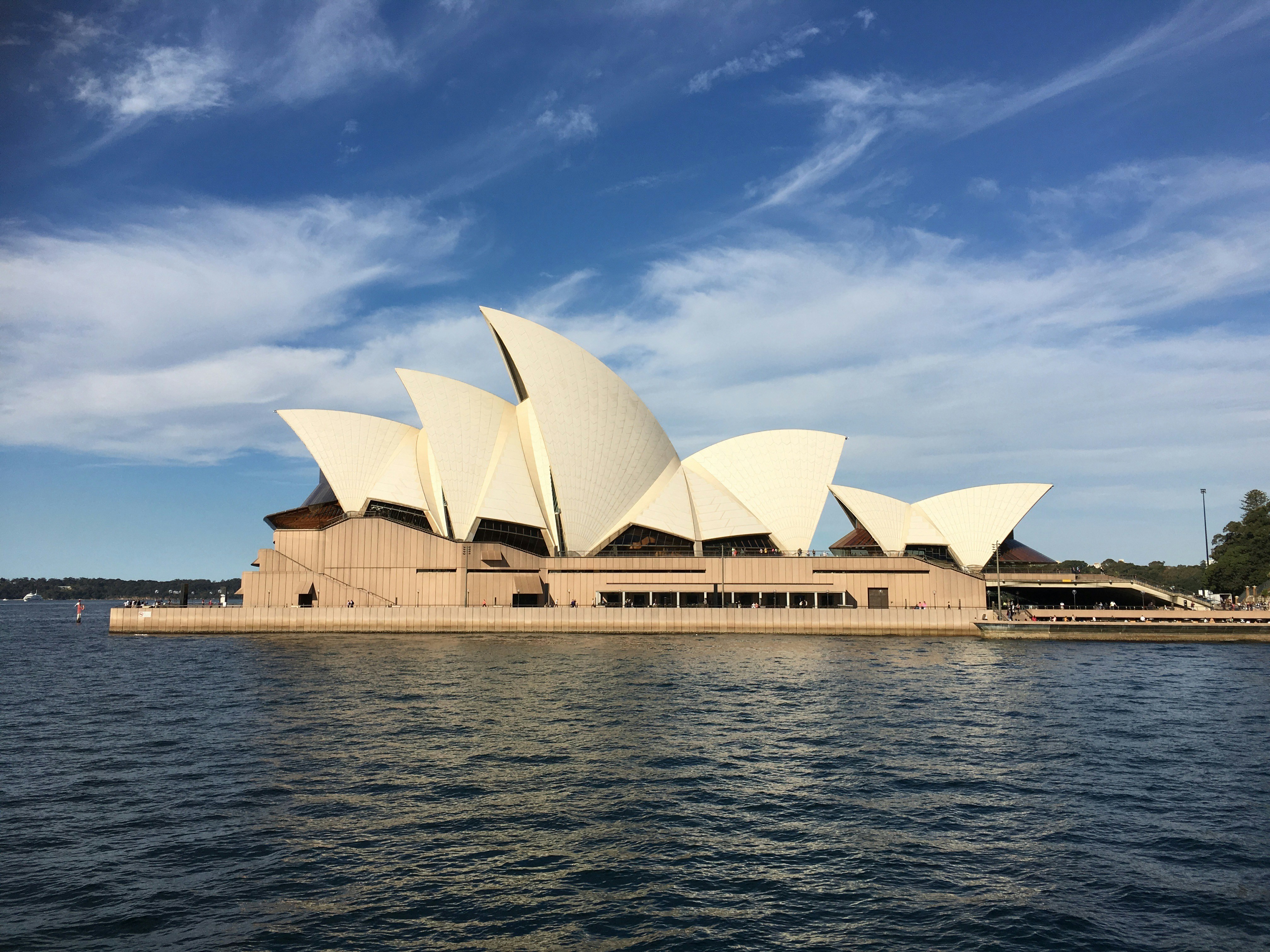 The sydney opera house in the middle of a body of water photo – Free ...