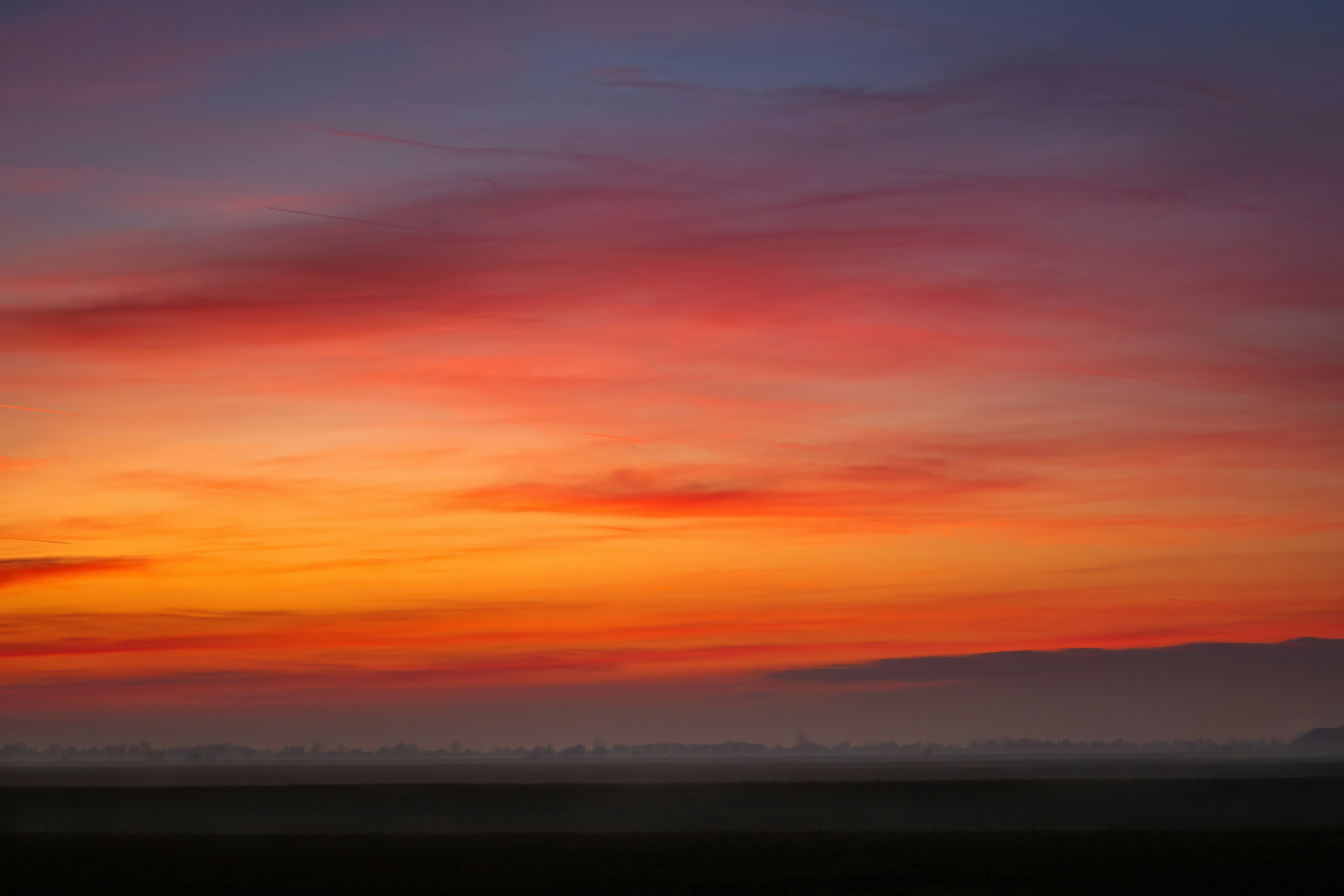 Ember Horizon: A Quiet Sunset Over the Distant Plain
