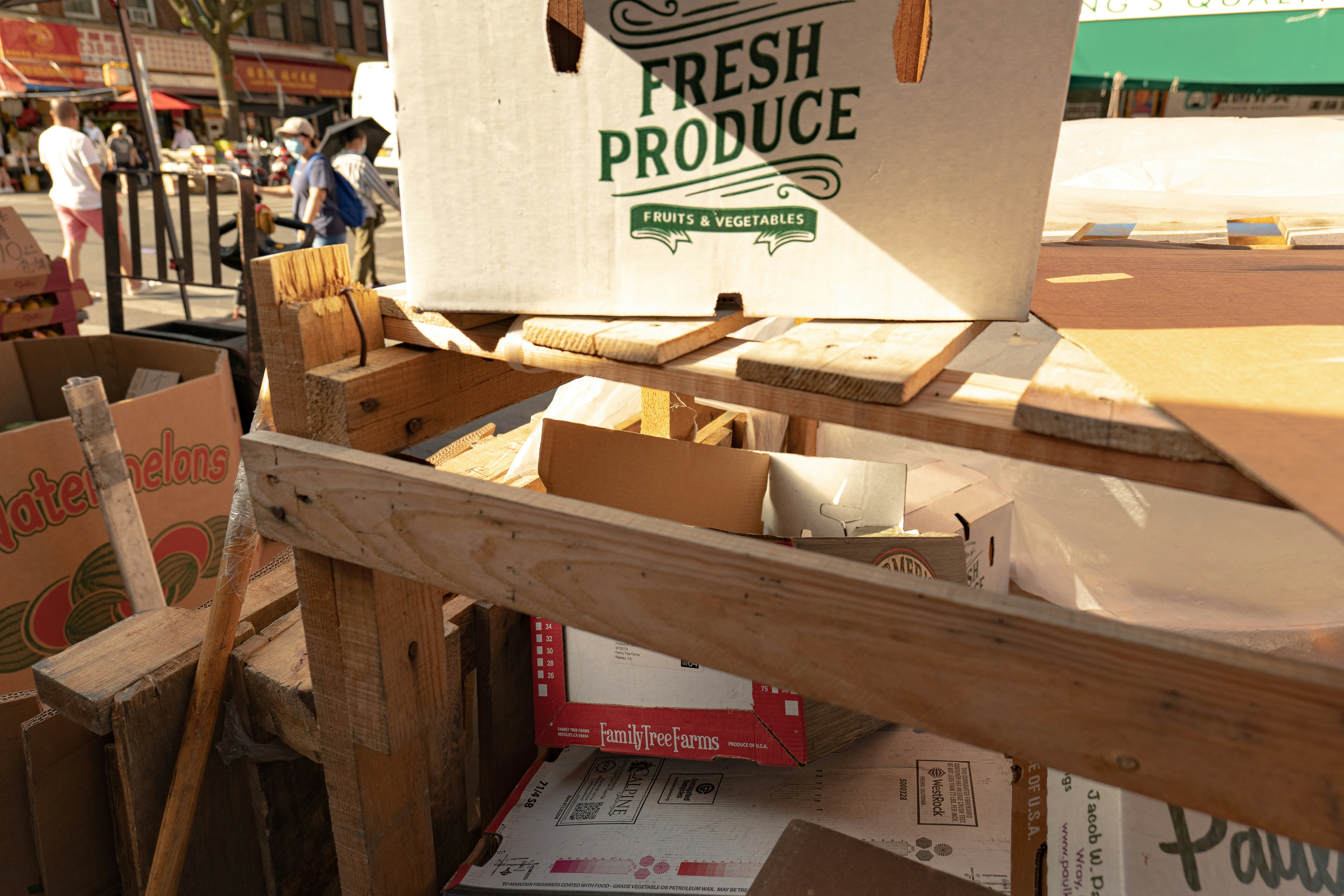 Sunlit Market Crate Display: Rustic Fresh Produce at a Busy Stall