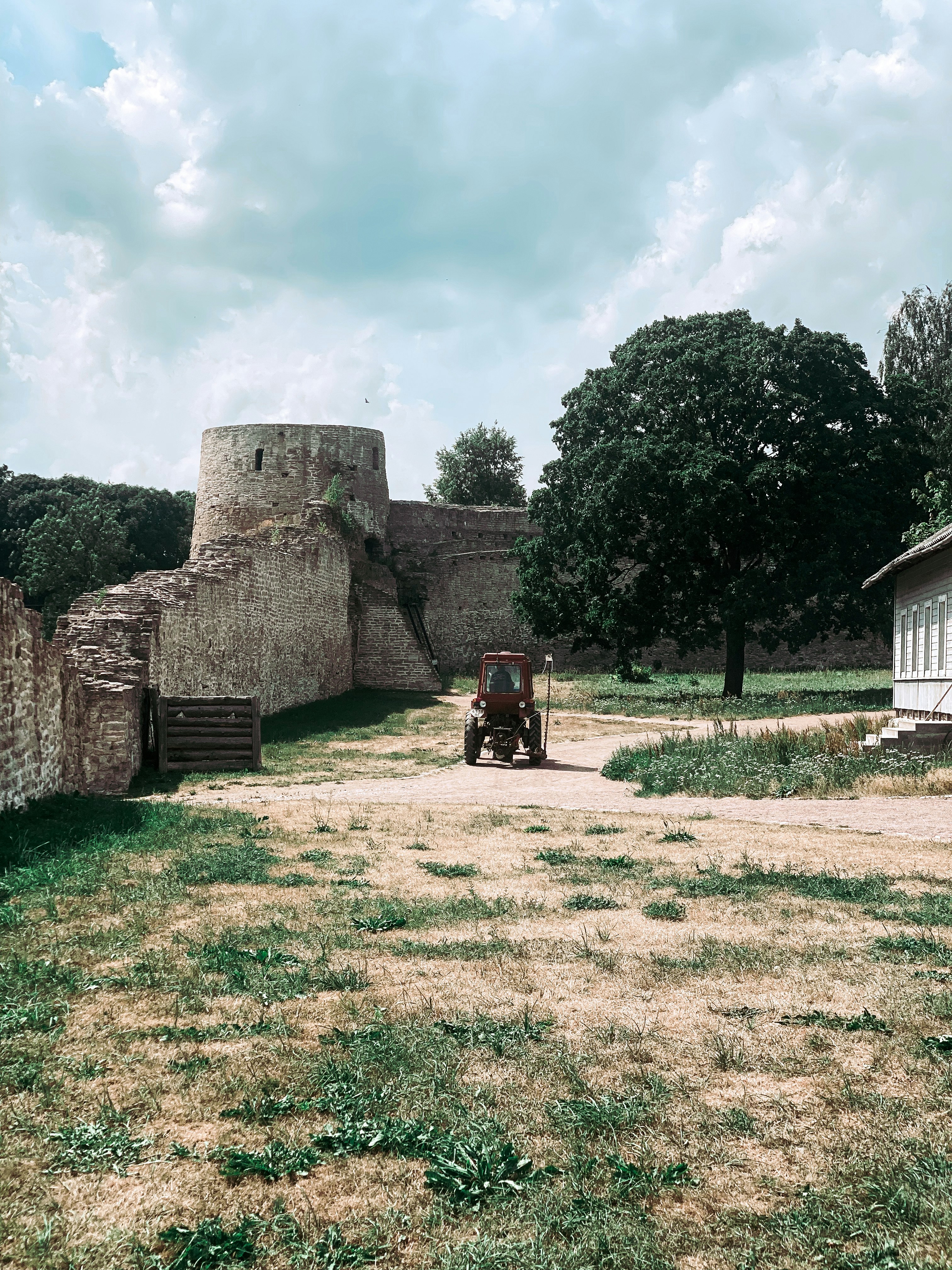 a tractor is parked in front of a castle