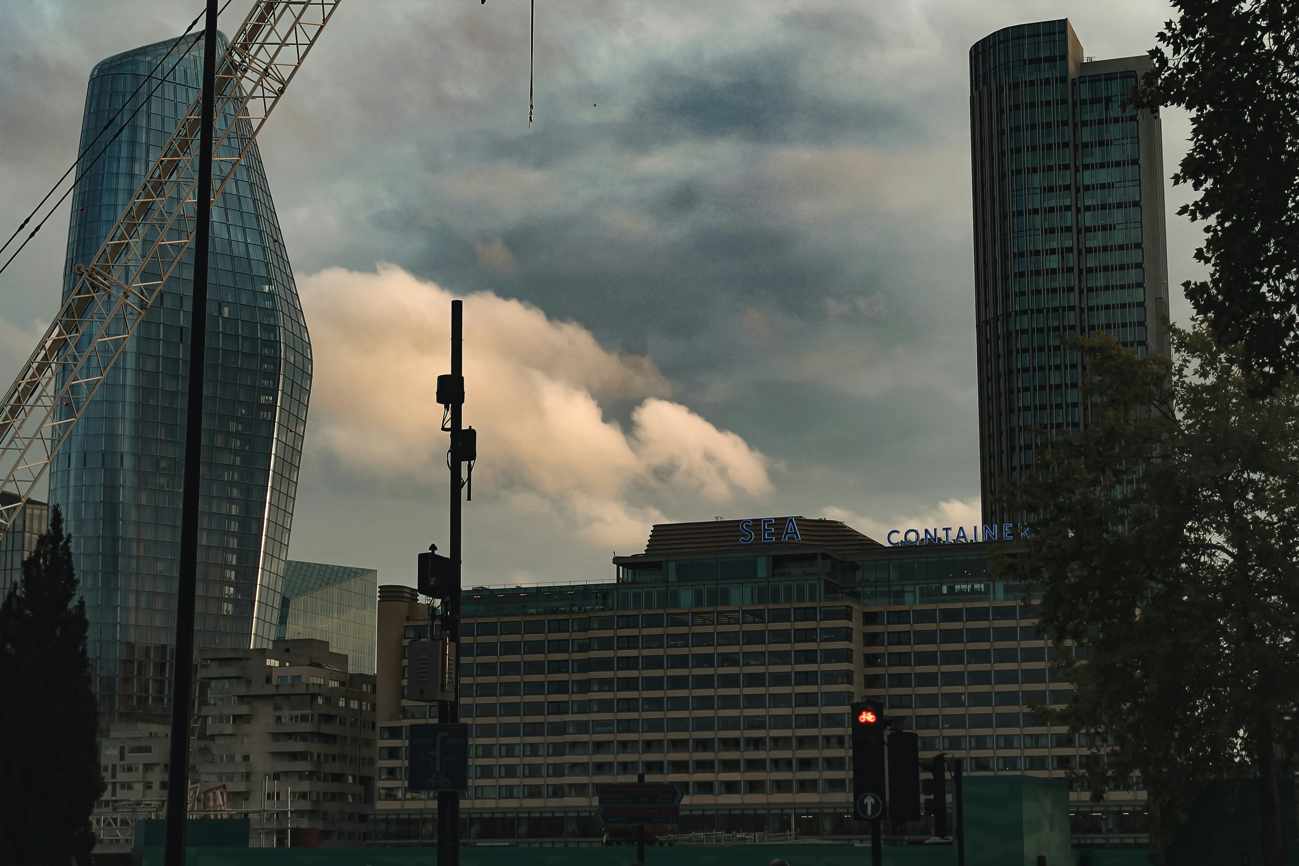 Crane Over a Glass Skyline: Clouds and City Lines