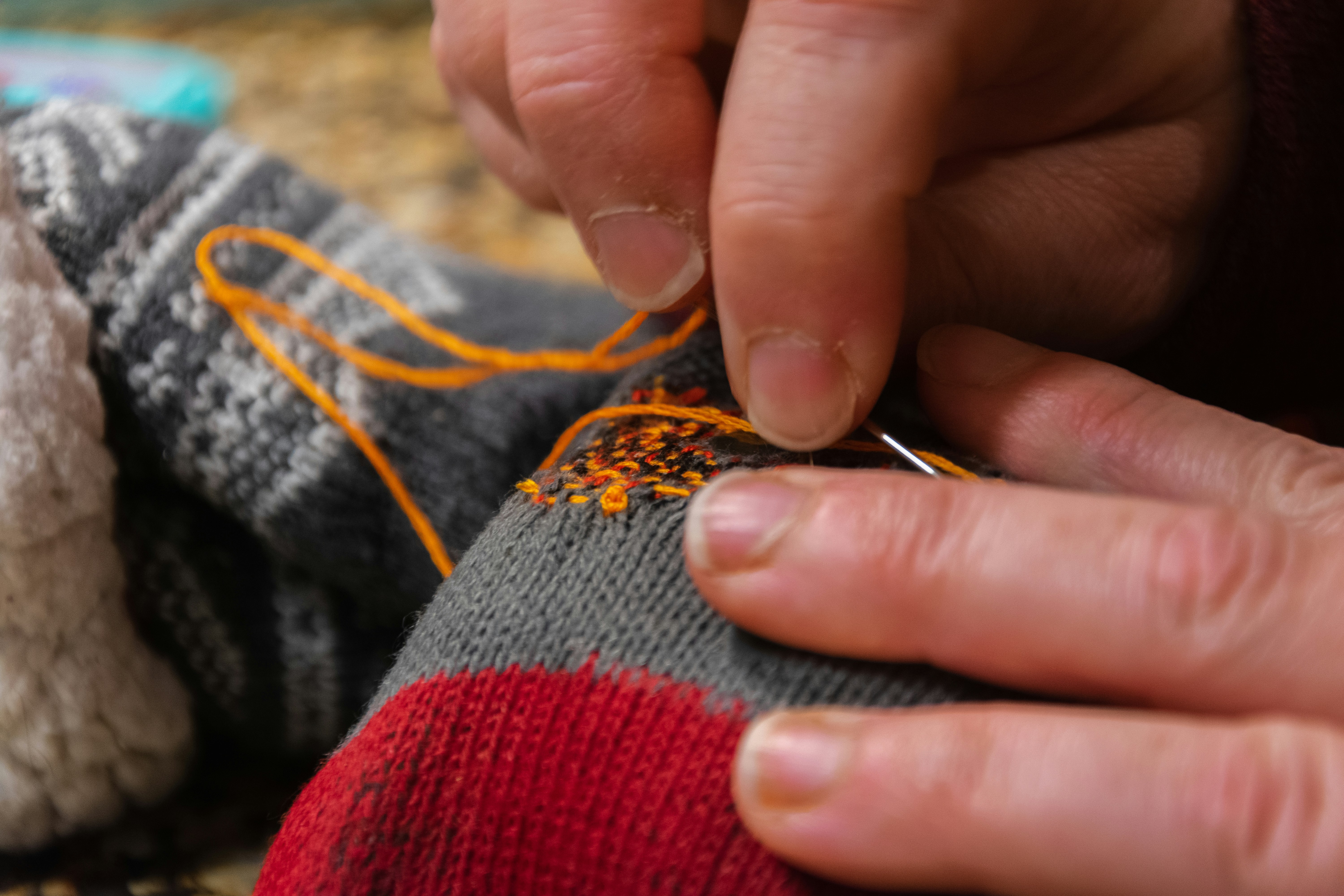 A person is stitching a sock with a pair of scissors photo – Free ...