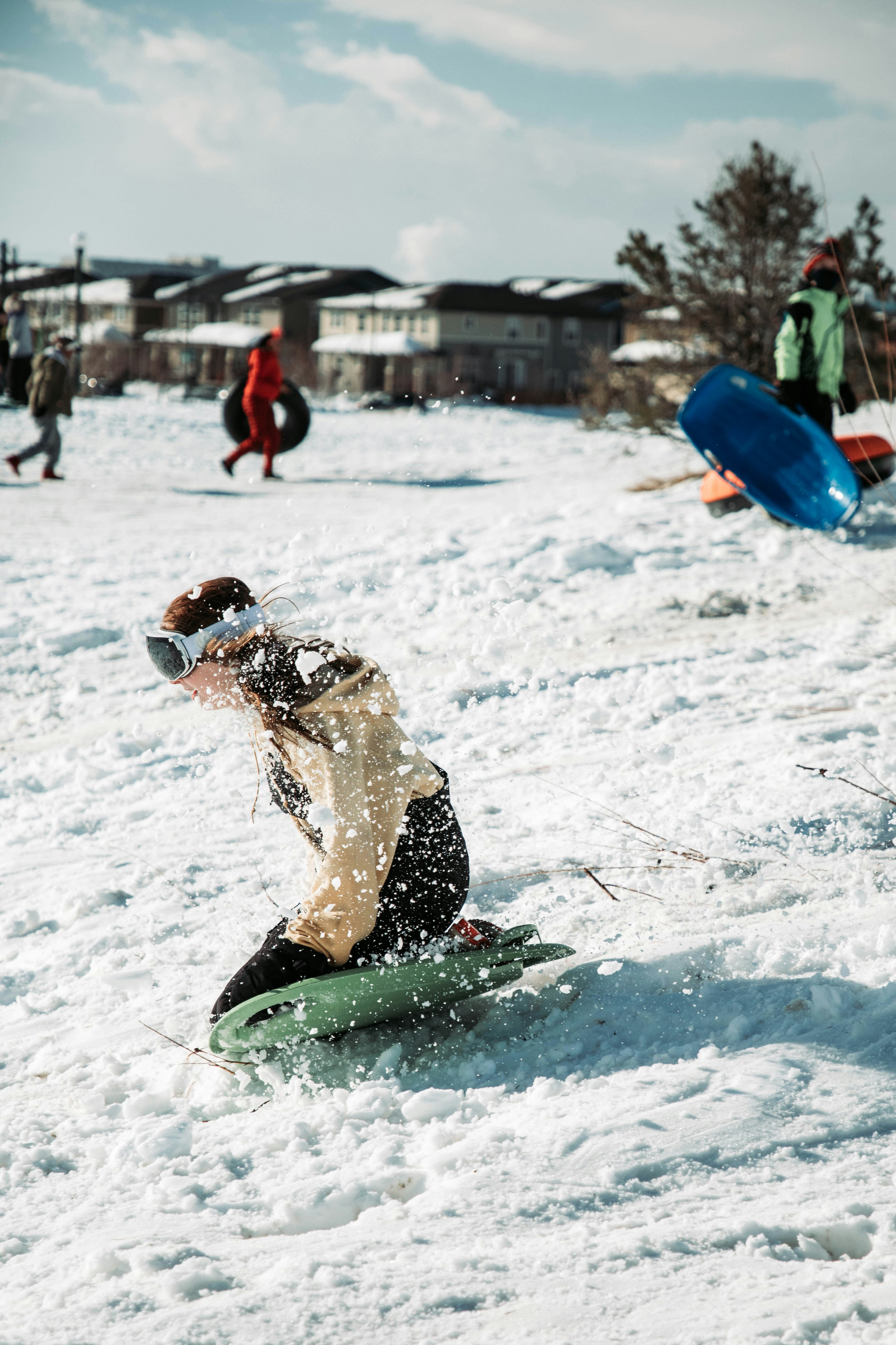 A person riding a snowboard down a snow covered slope photo – Free ...