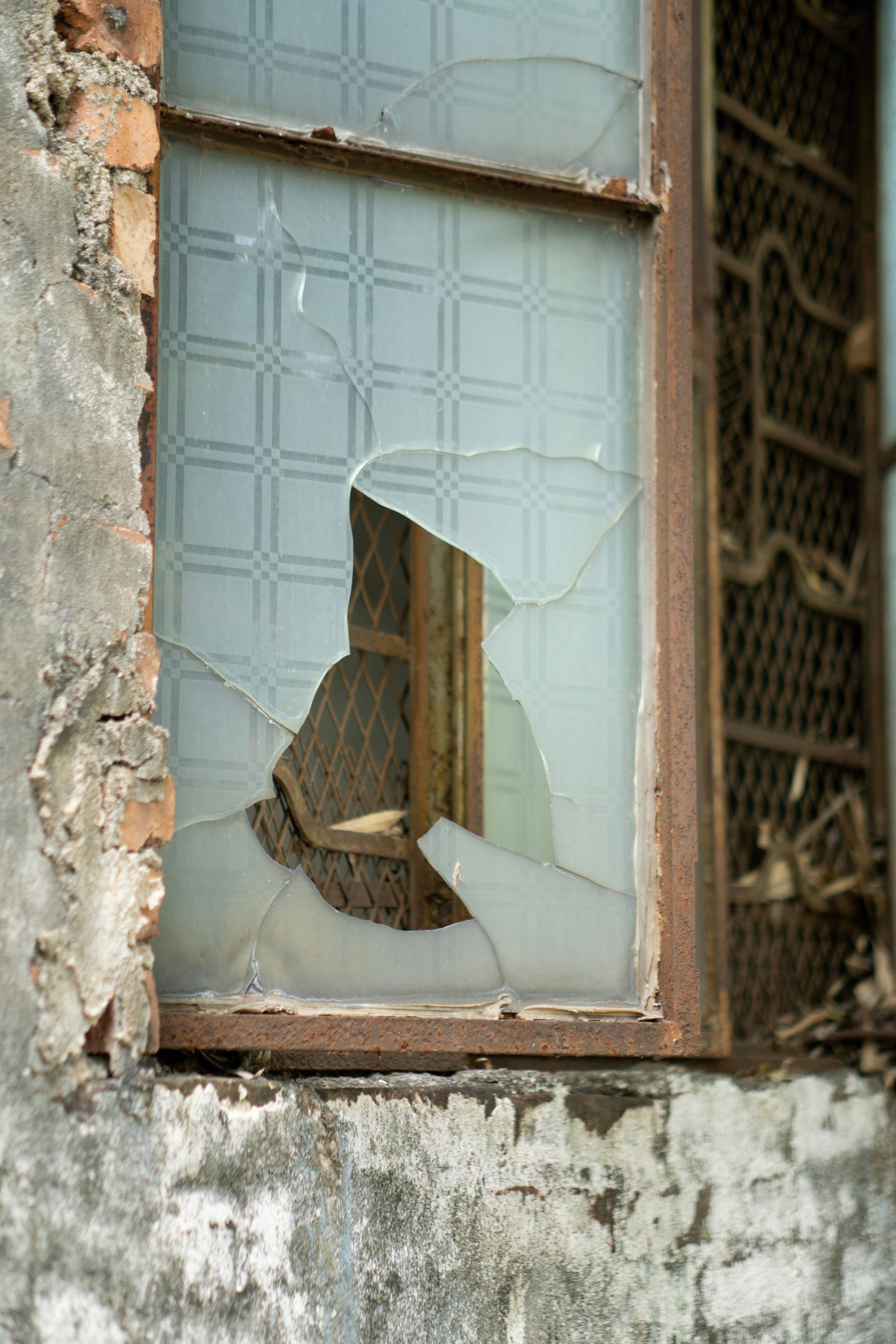 A broken window with a hole in it photo – Free Image on Unsplash