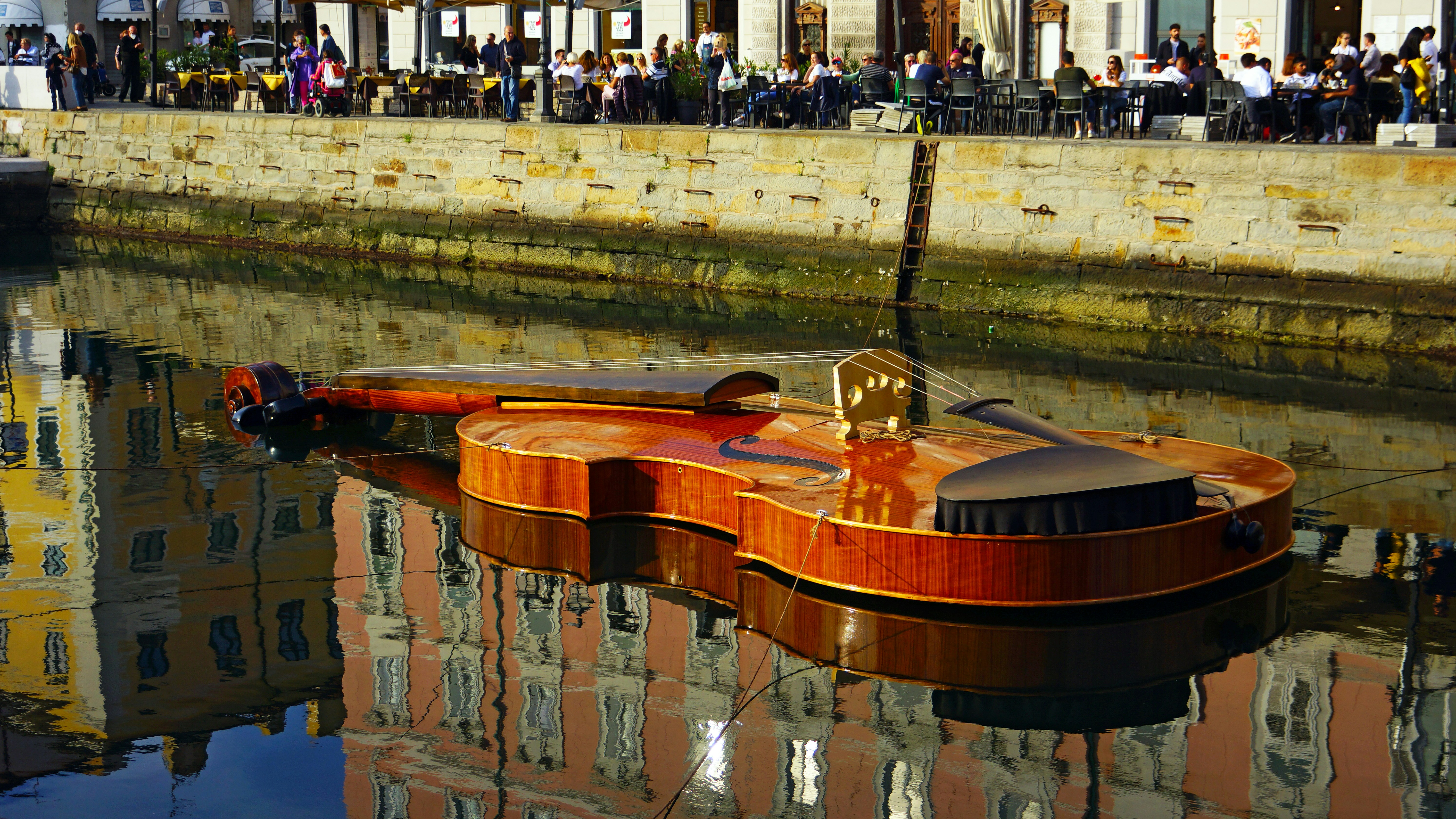 a wooden boat floating on top of a body of water