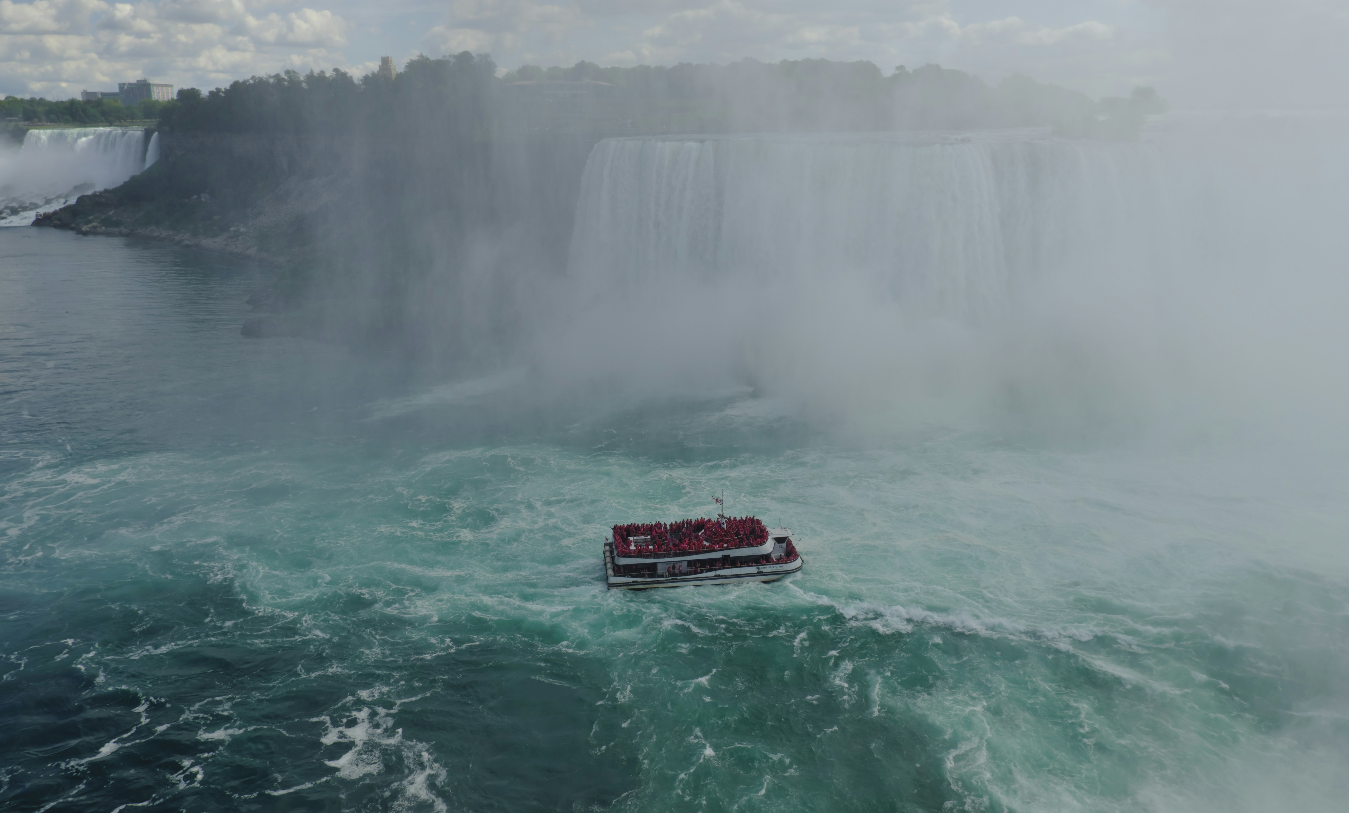 A boat in a body of water near a waterfall photo – Free Niagara falls ...
