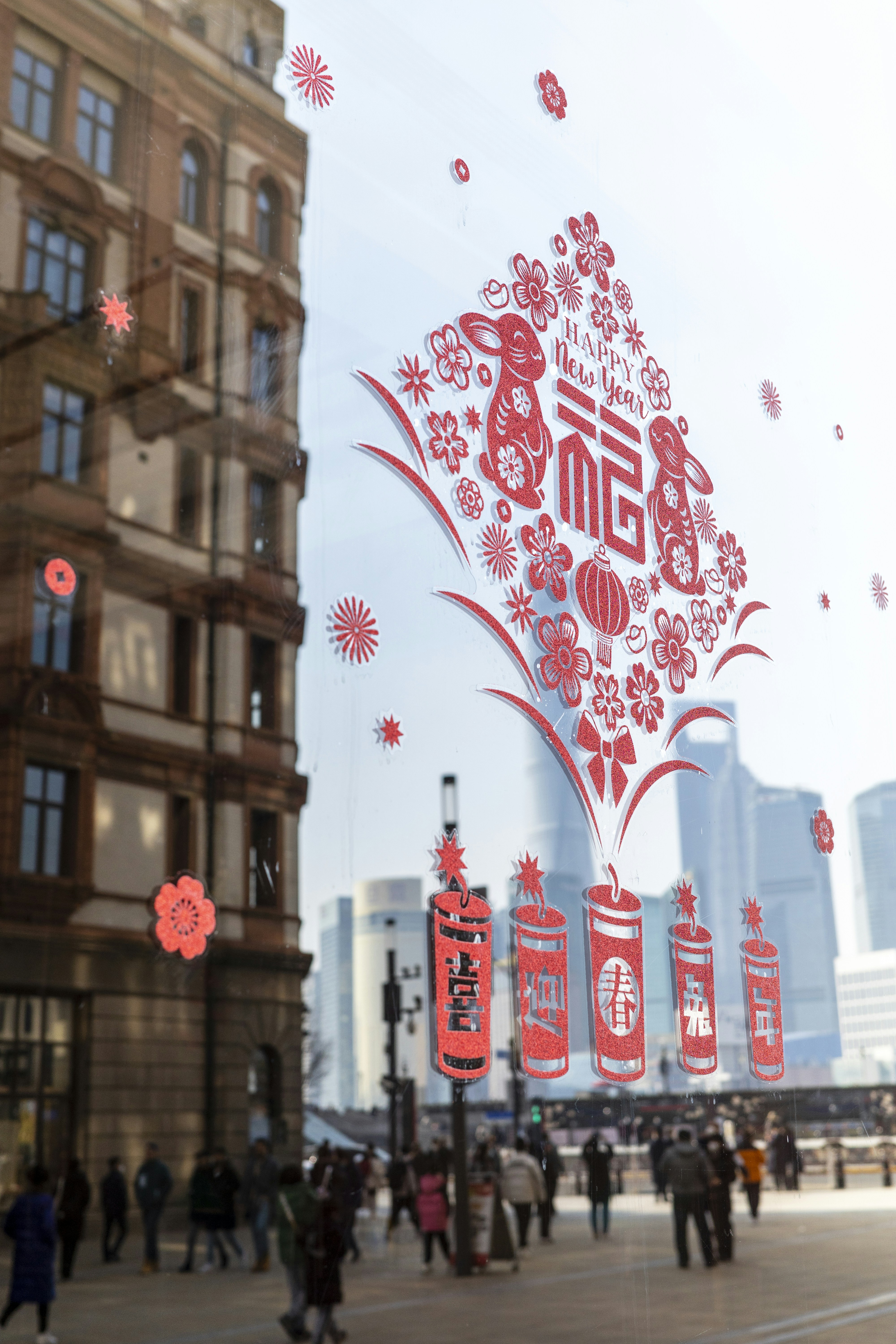 Lunar Festival on Glass: Red Ornaments Framing a Busy City Street