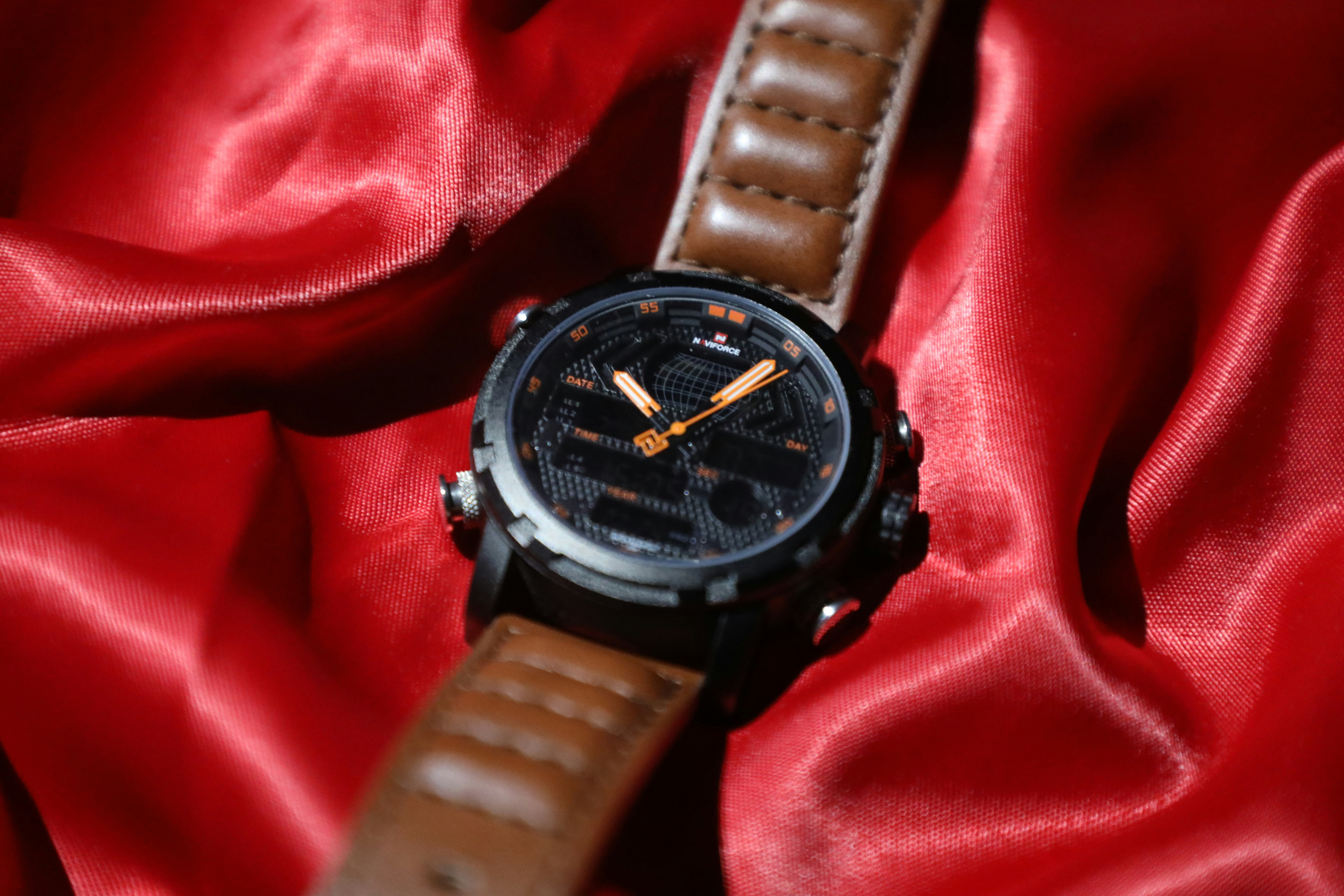Copper Hands on Crimson Satin: A Watch in Quiet Repose