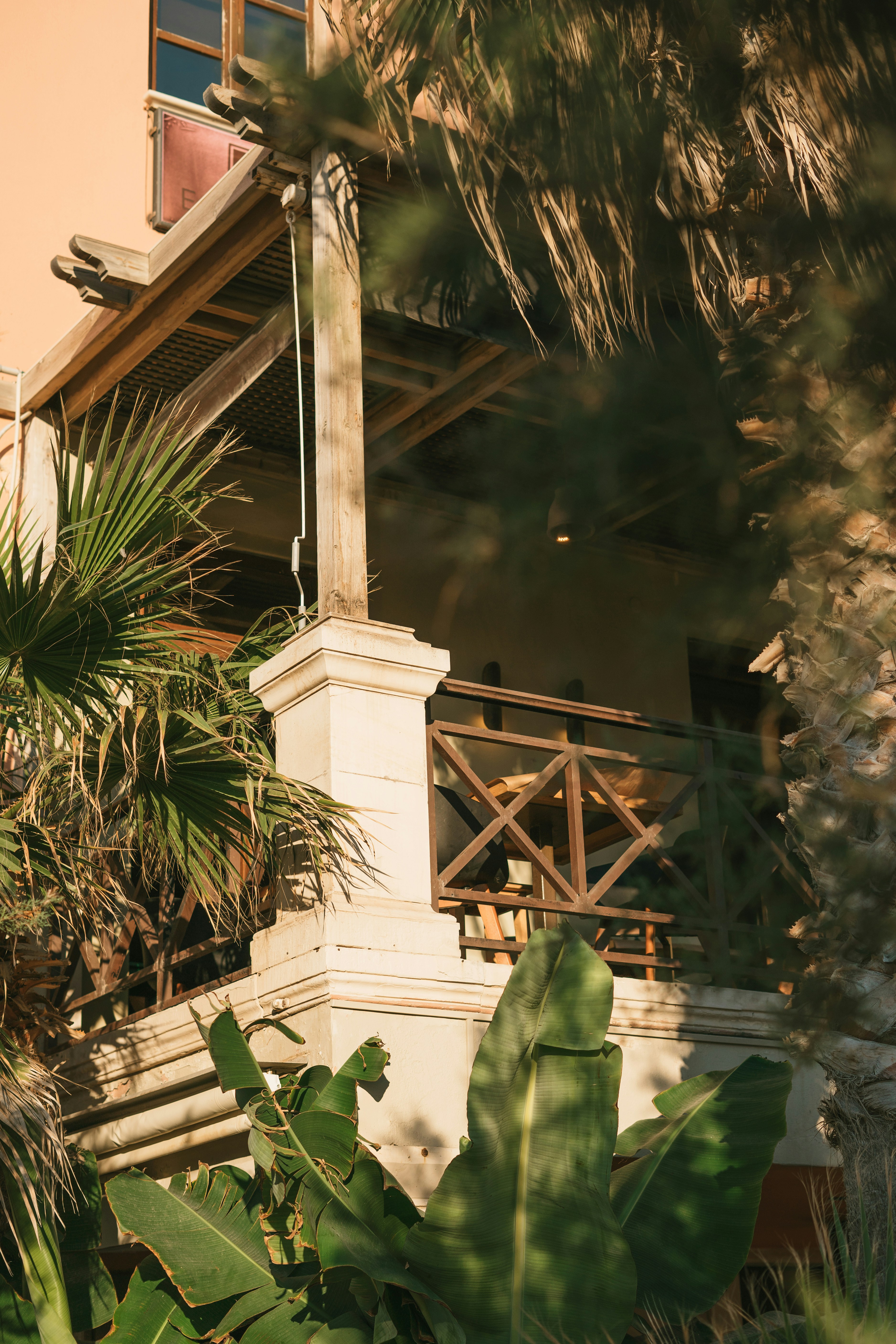 A charming coastal structure framed by lush tropical plants, showcasing a blend of natural and architectural beauty.