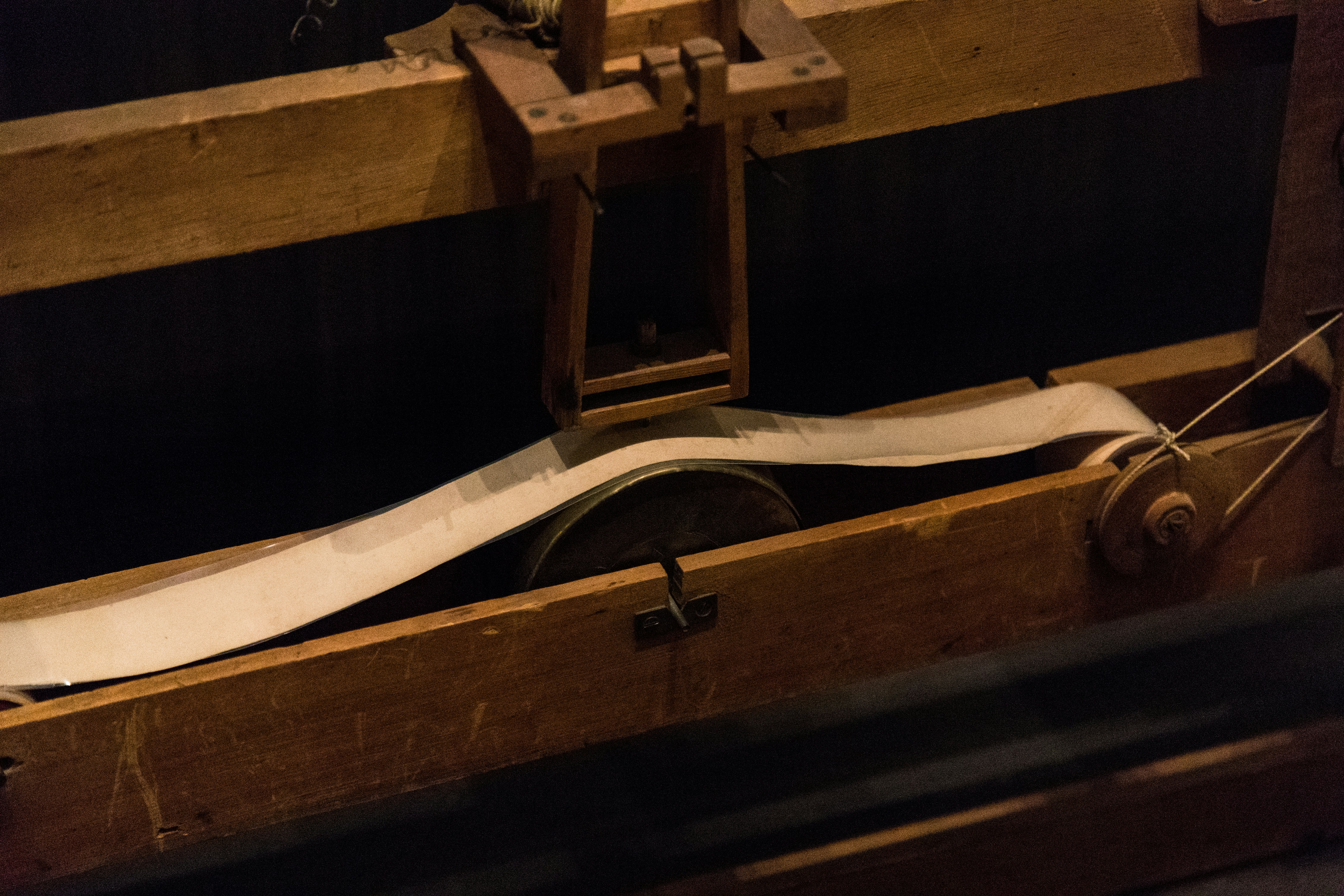 Whispering Belt over Timberwork: A Dim Workshop Moment