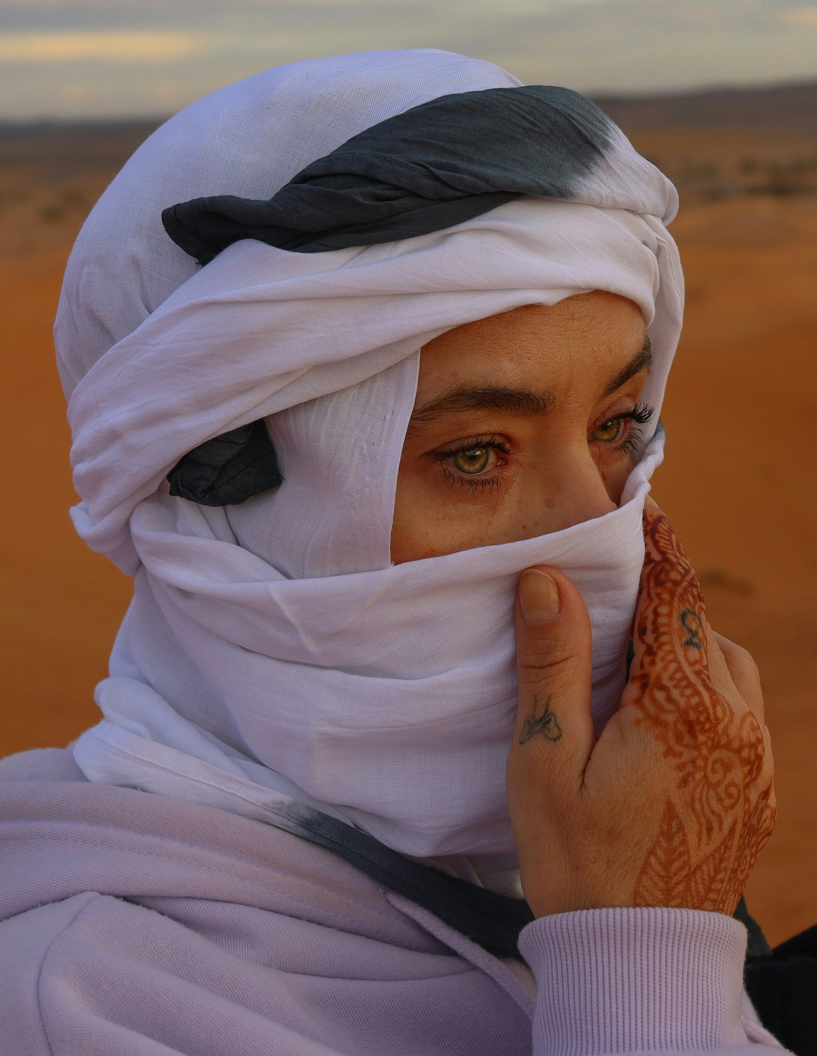 Desert Veil: Gaze Through White Linen and Henna