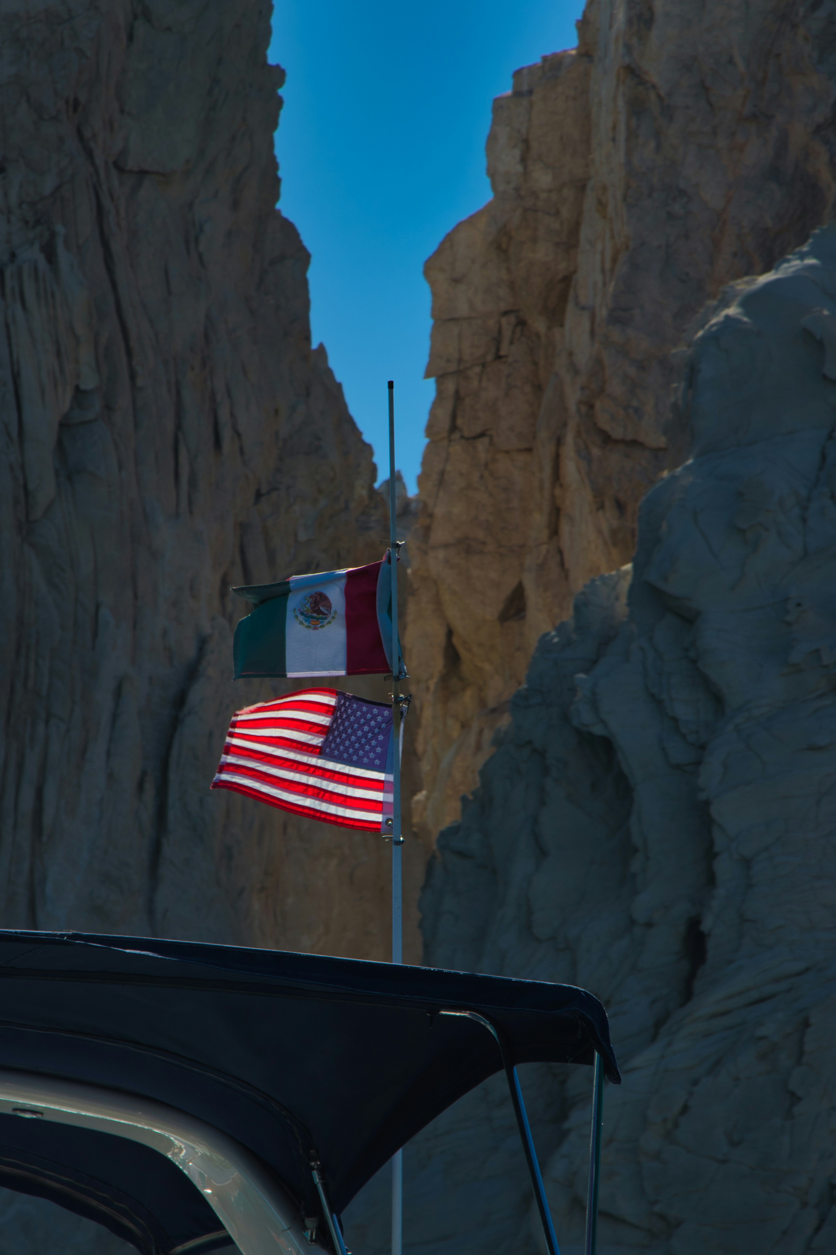 Flags in a Canyon: A Quiet Moment Between Rock Walls