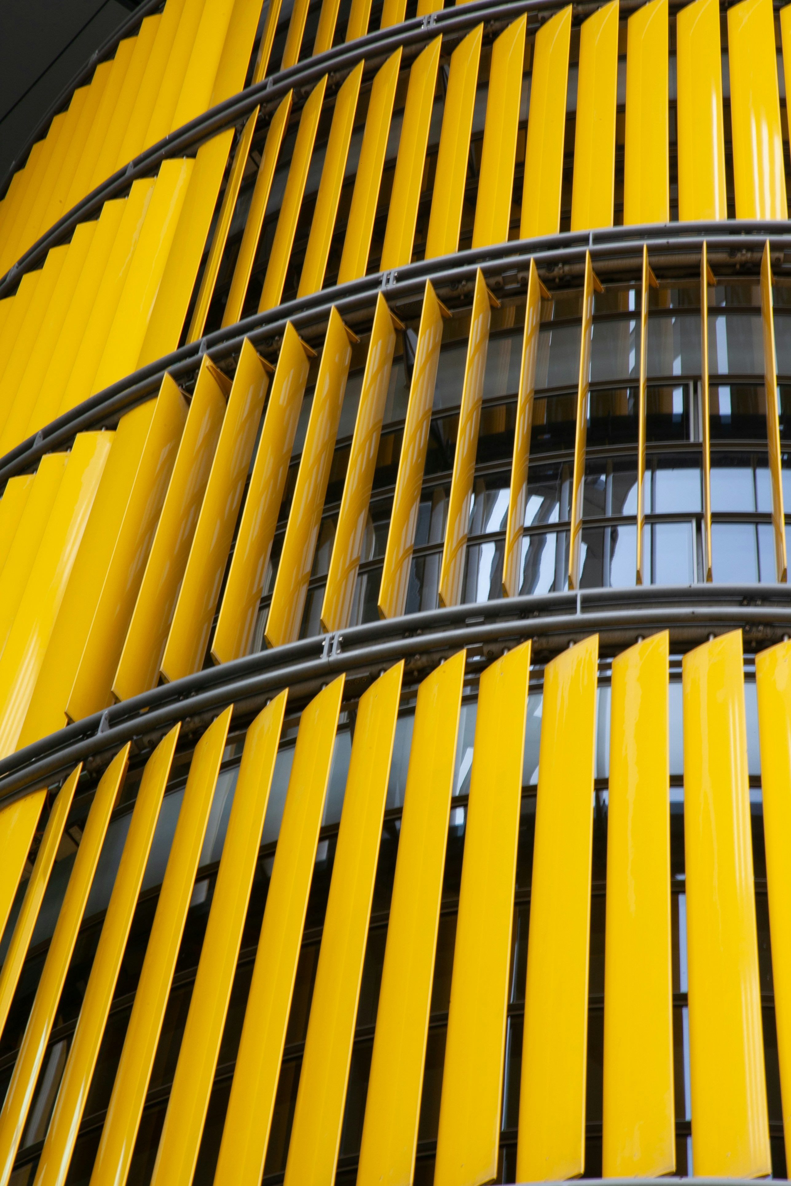 a close up of a yellow building with a circular window