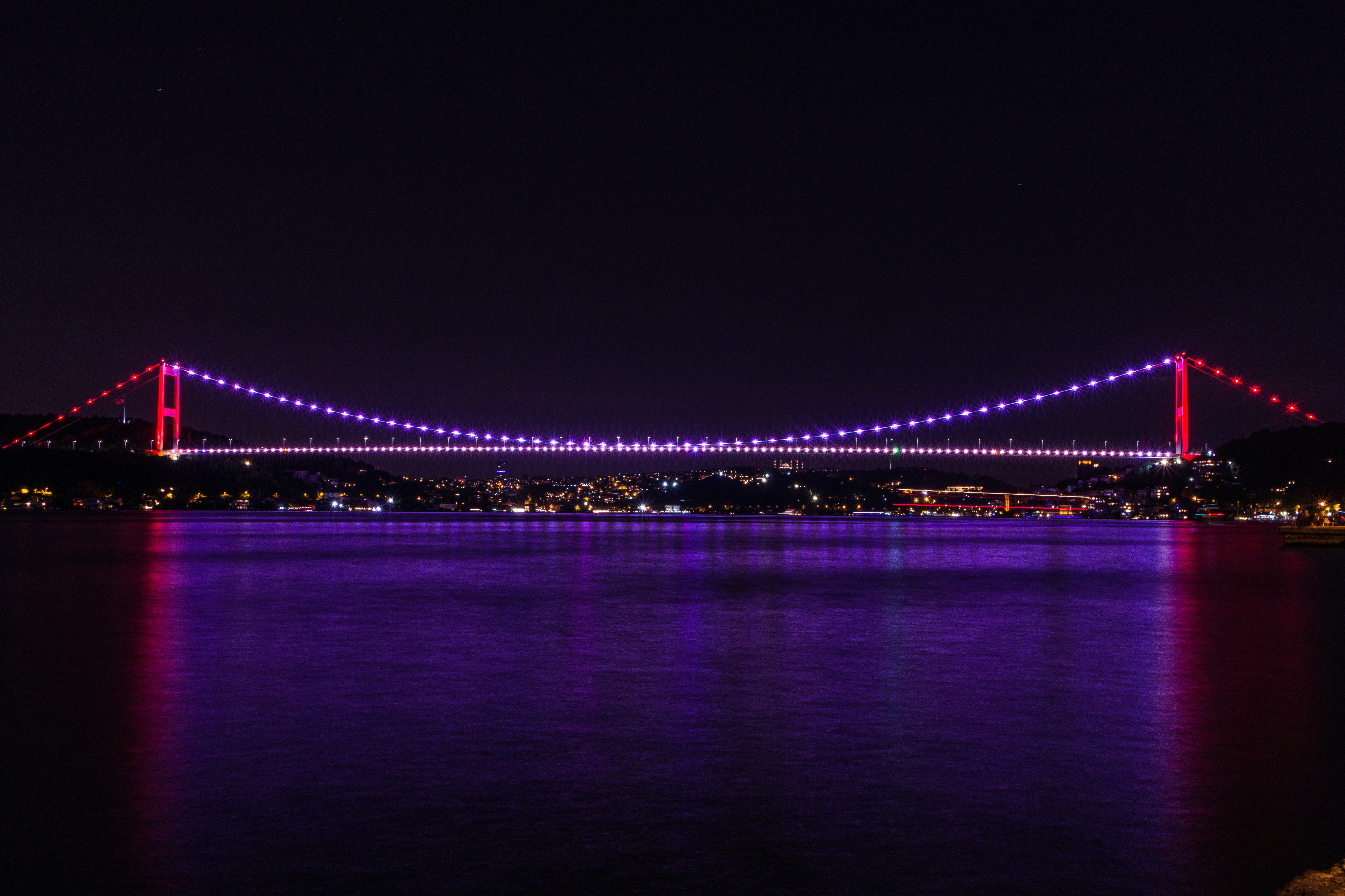 Neon Thread Across Midnight: A Suspension Bridge Draped in Purple Light