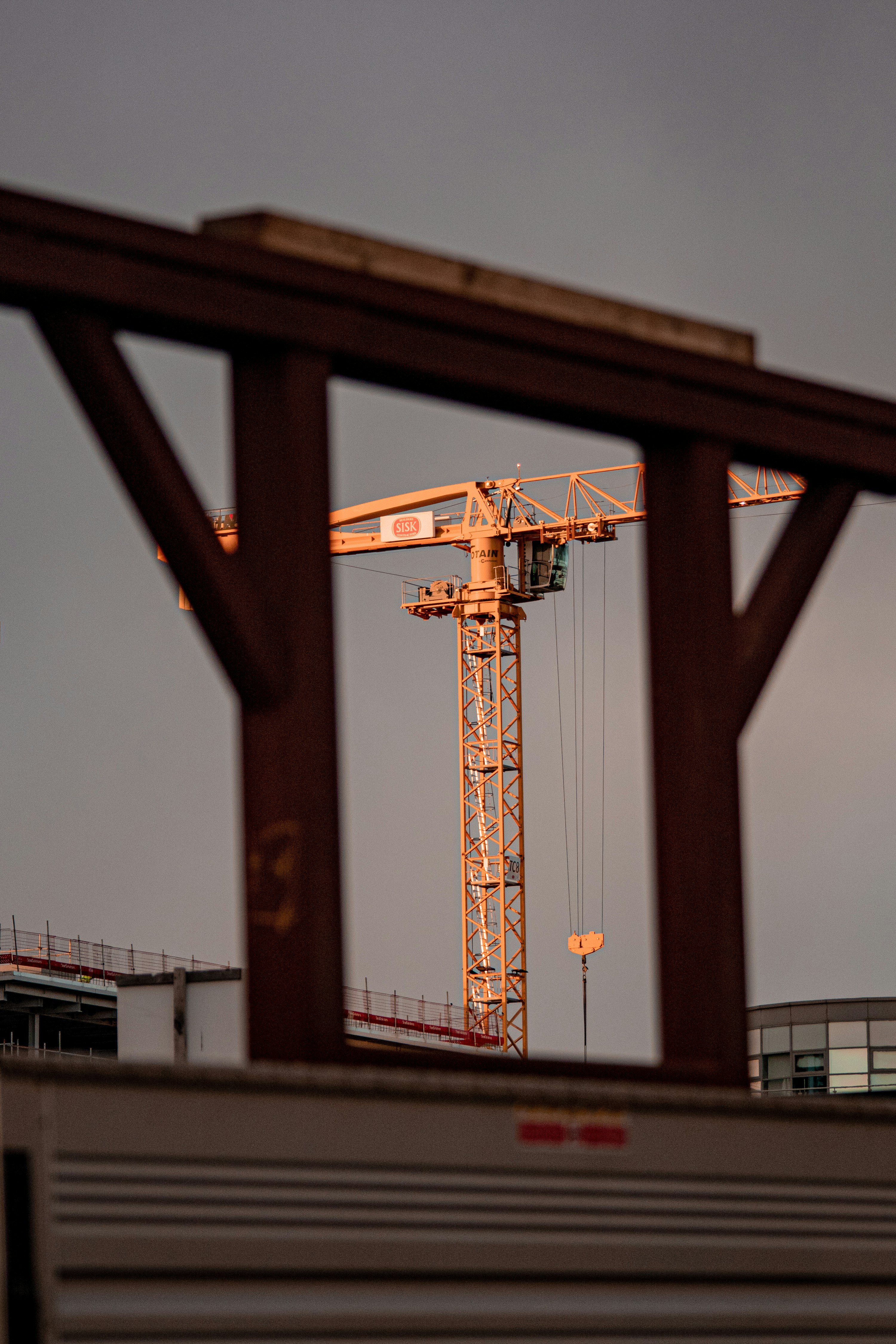 a crane is seen through a window of a building