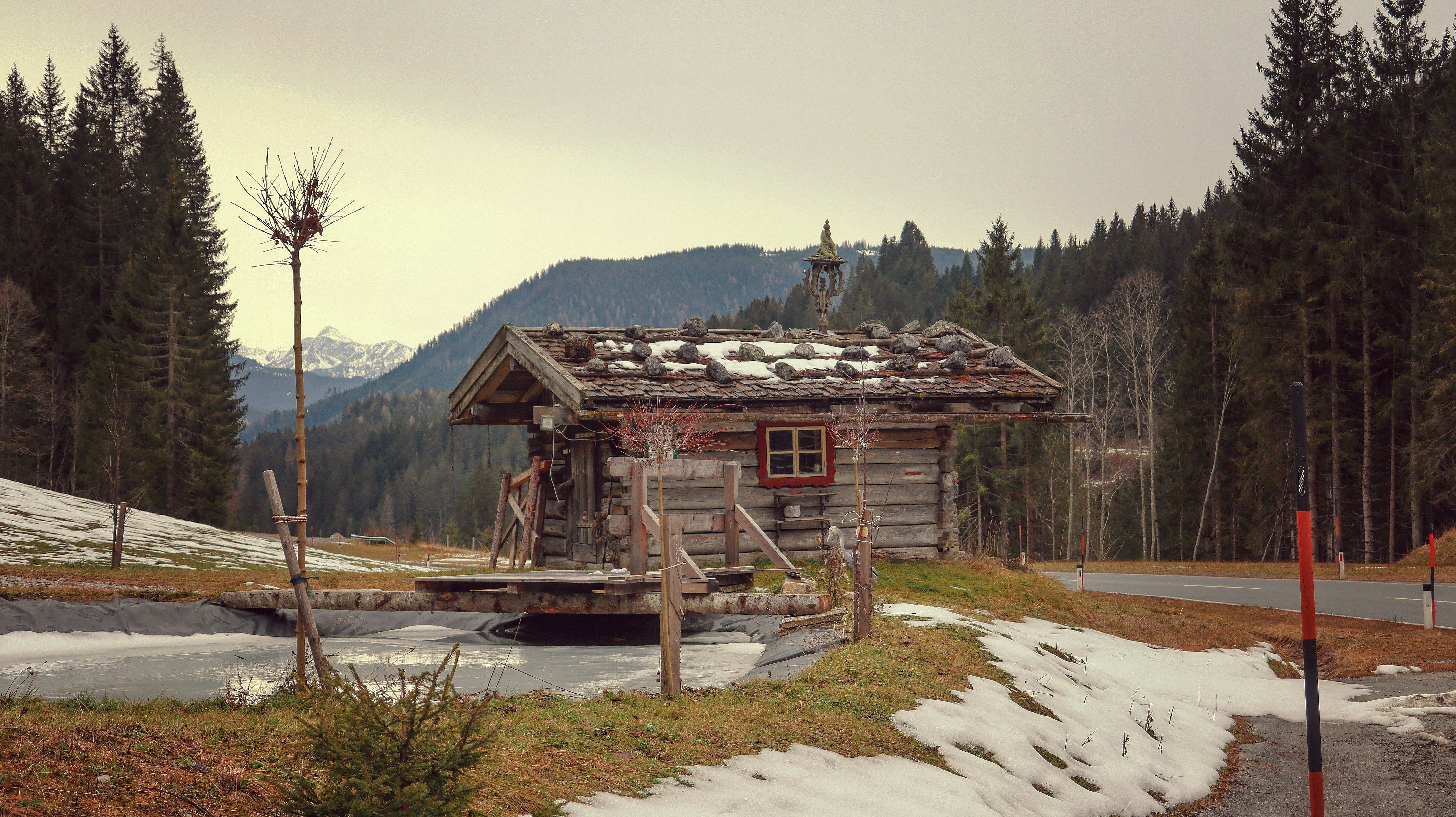 a log cabin in the middle of a snowy forest