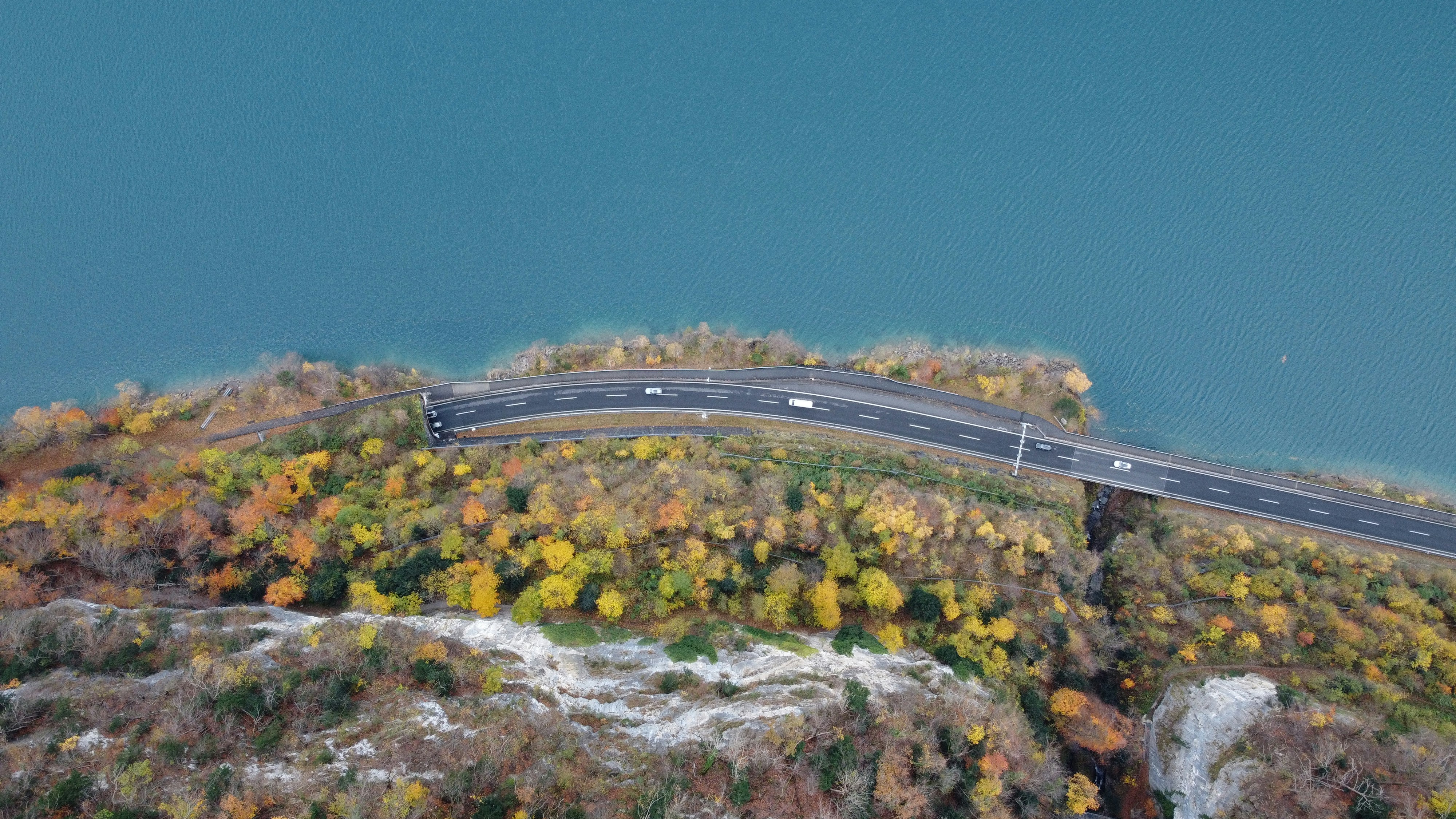 An aerial view of a road going over a bridge photo – Free Waterfall ...