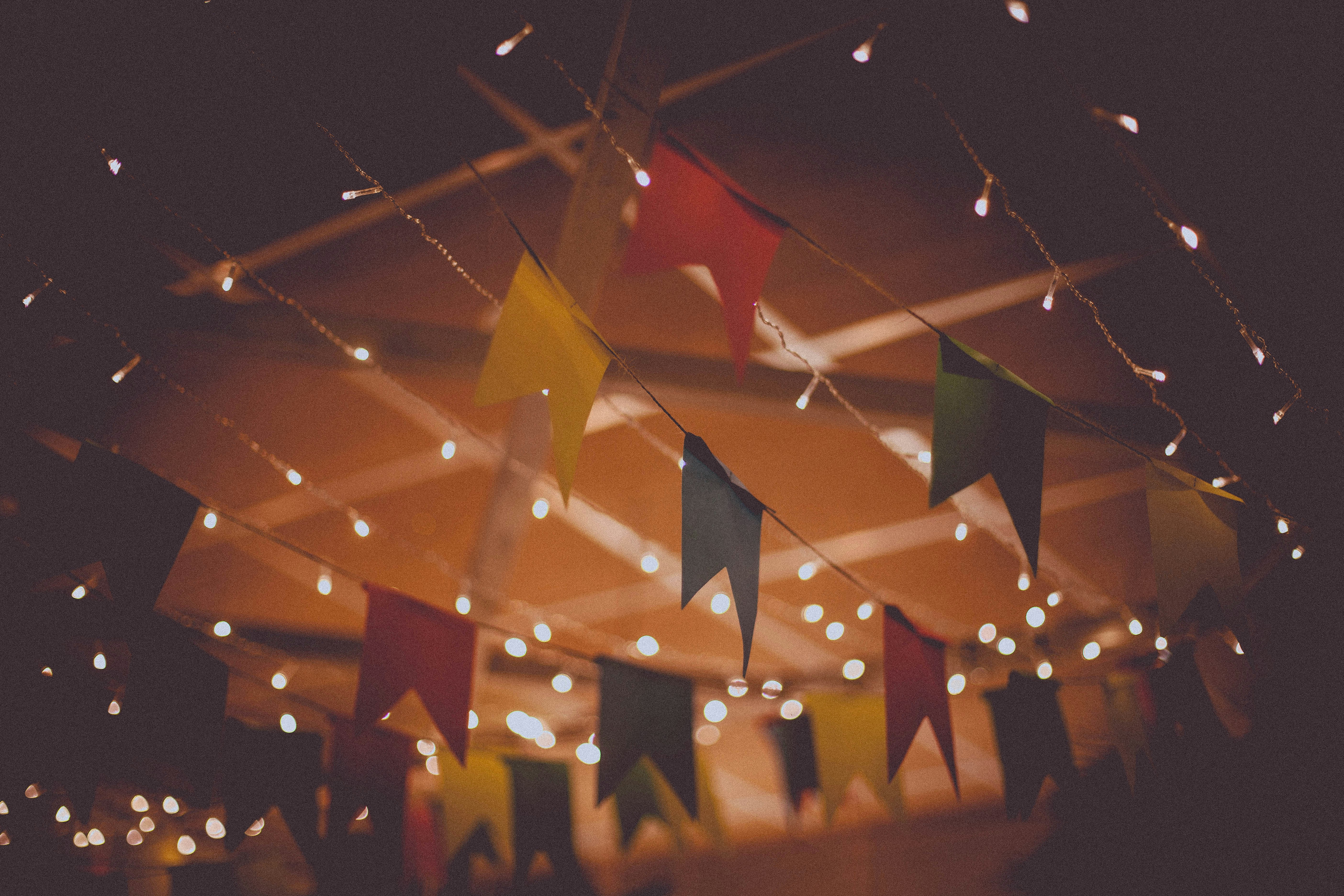 A group of colorful flags hanging from a ceiling photo – Free Flag ...