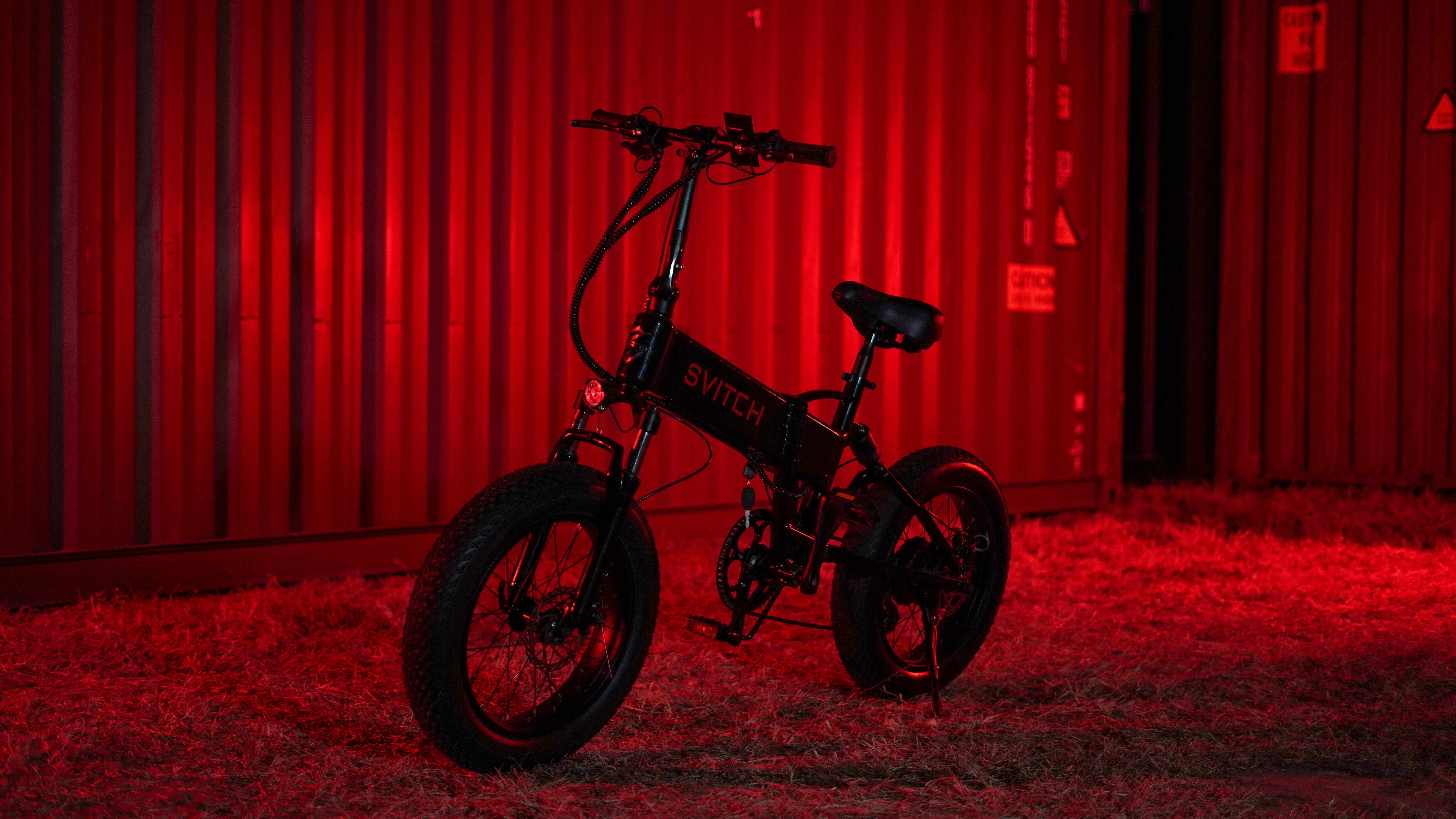 Red Hour, a Switch folding bike under industrial neon glow