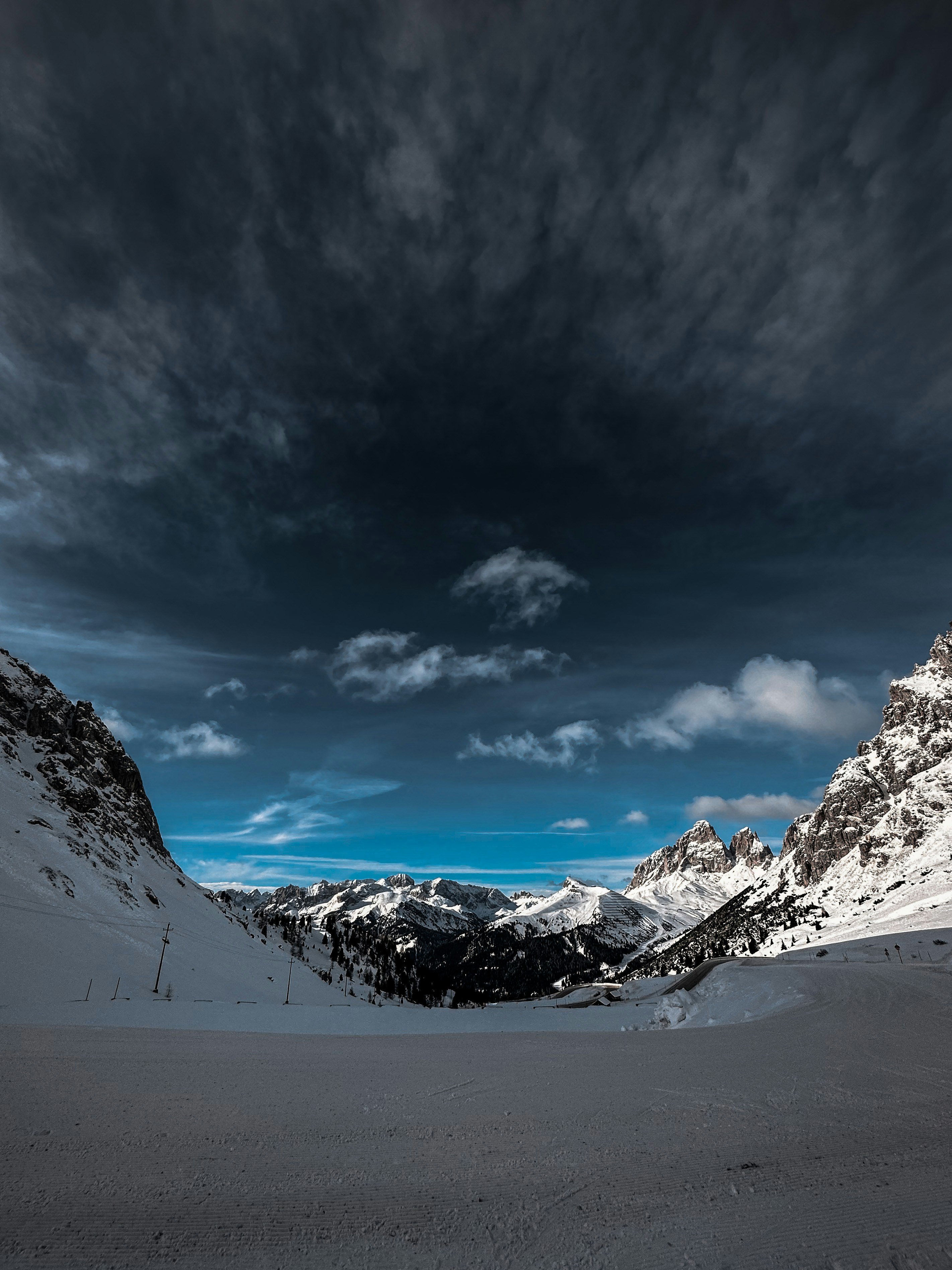 Snowbound Silence: A Rim of Peaks Beneath a Widening Sky
