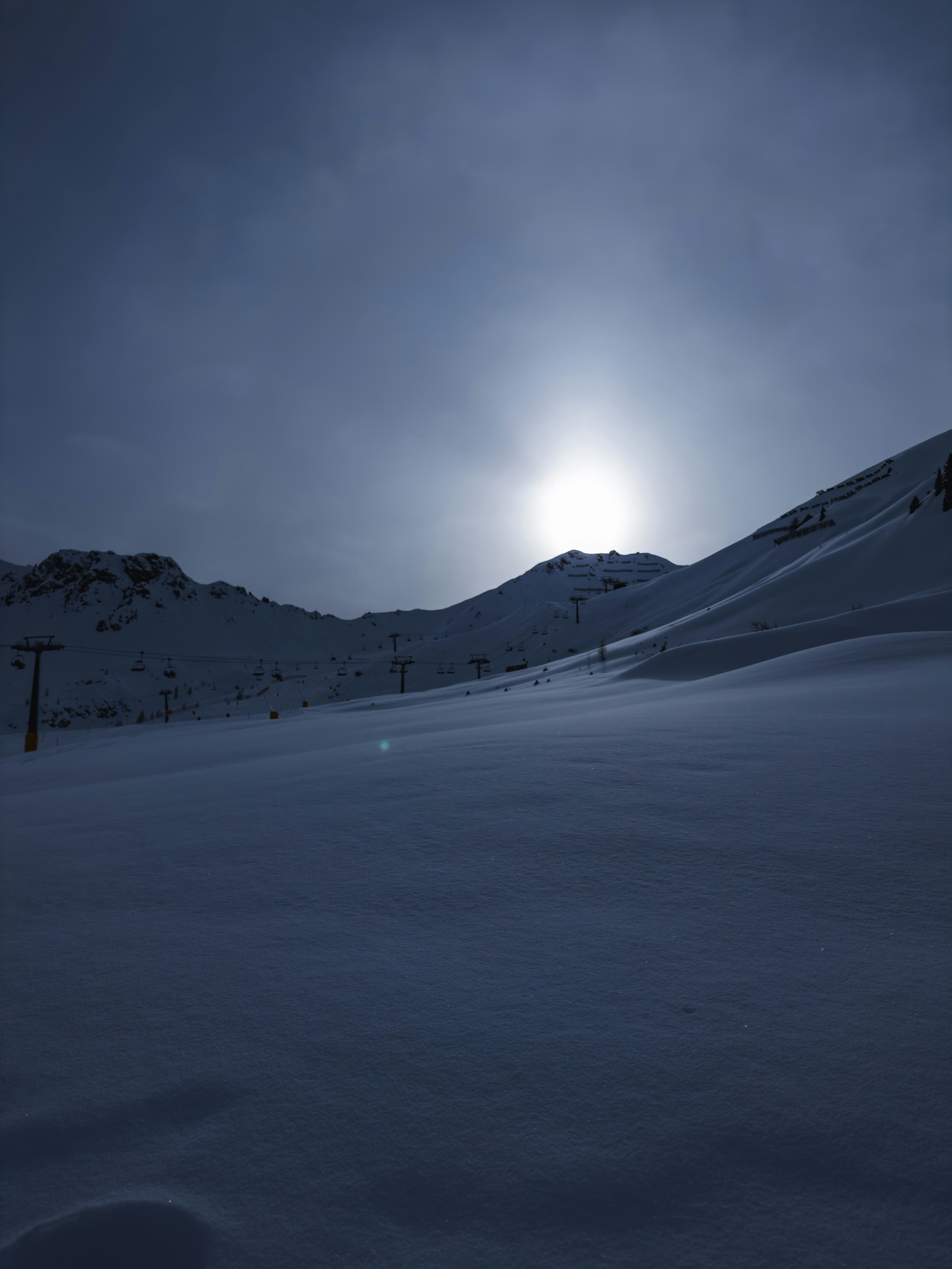 Sunlit Silence over a Snow-Covered Slopescape