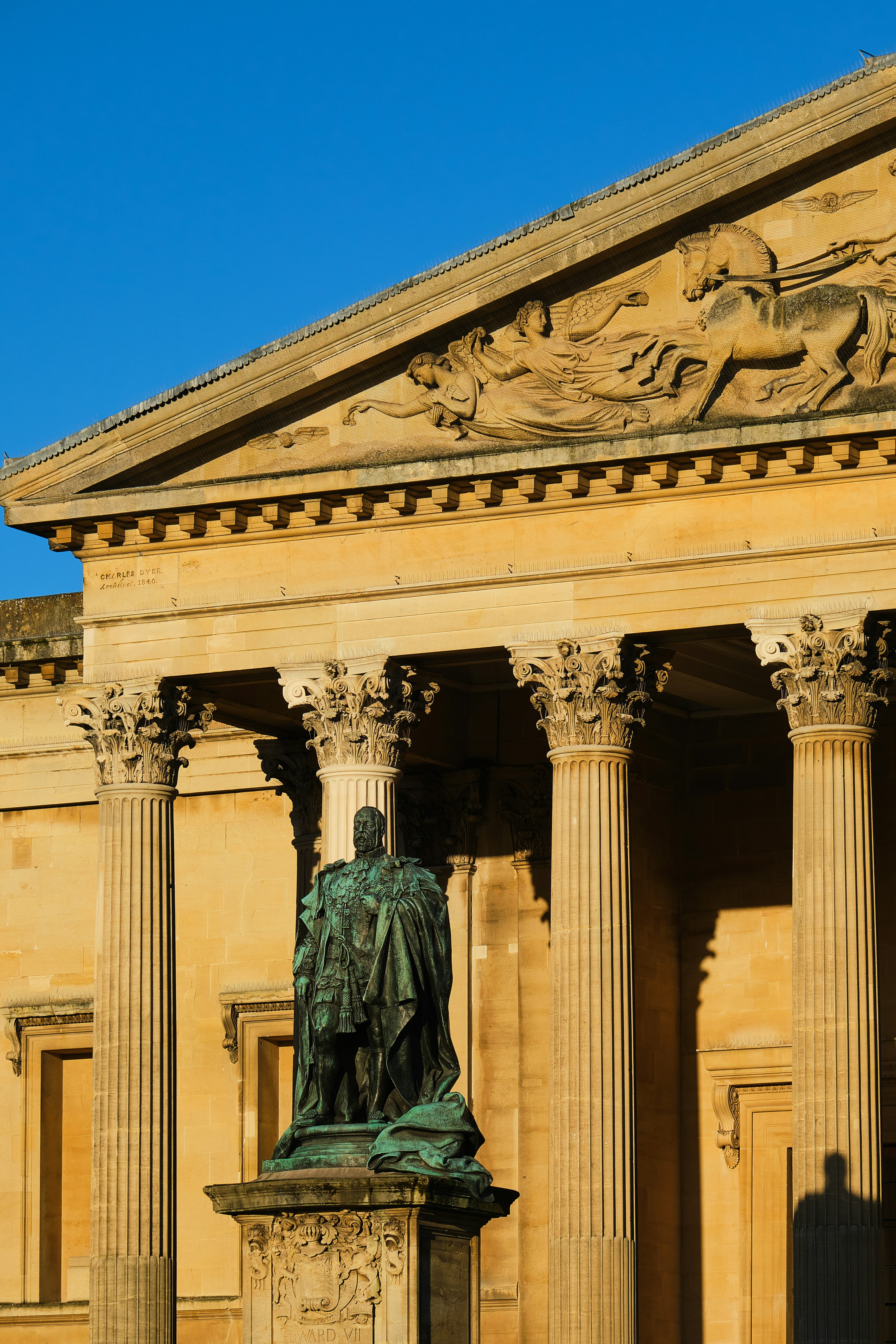 a statue of a man in front of a building