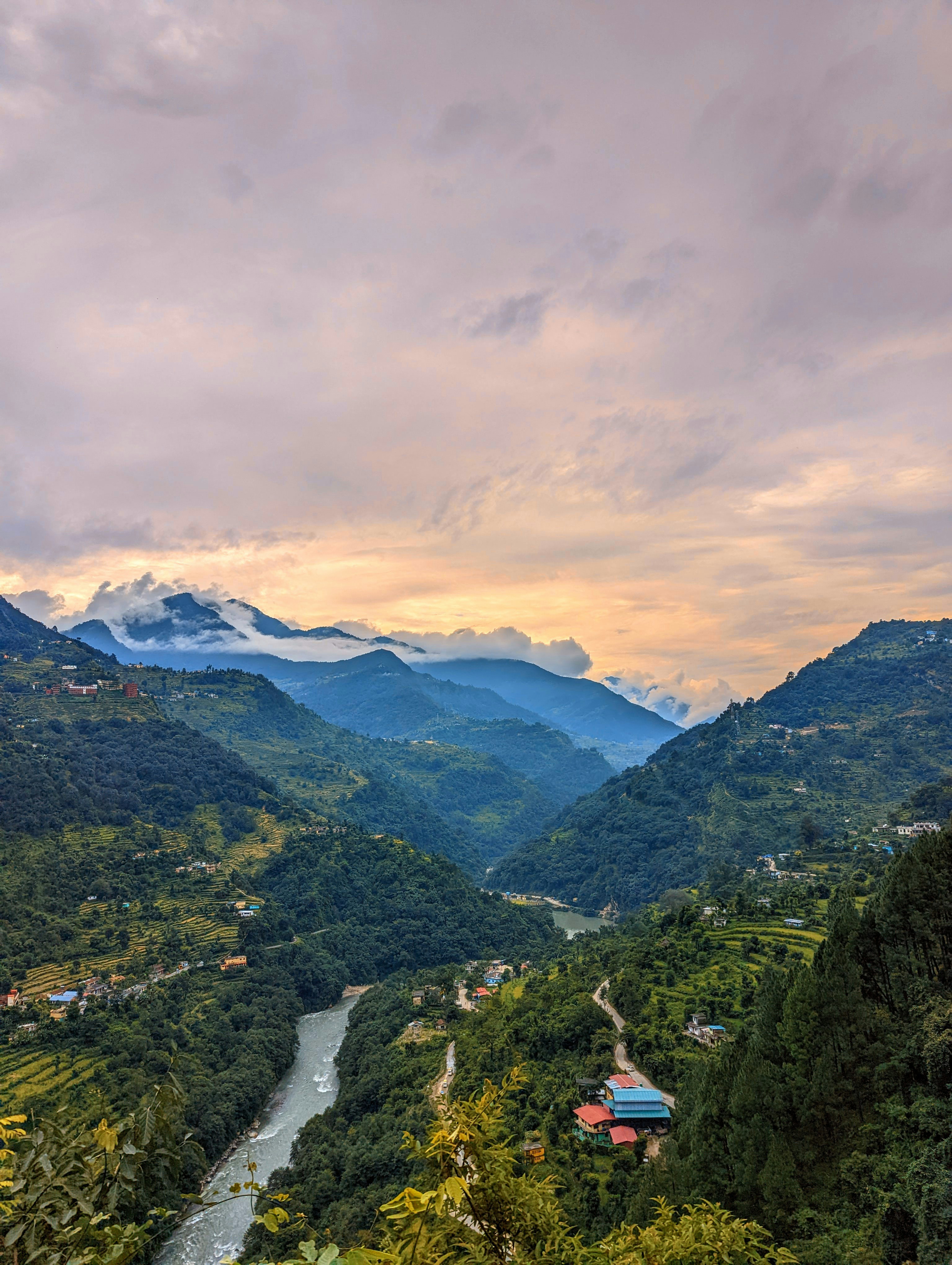 Terraced Valleys, a Winding River, and Sunset Echoes