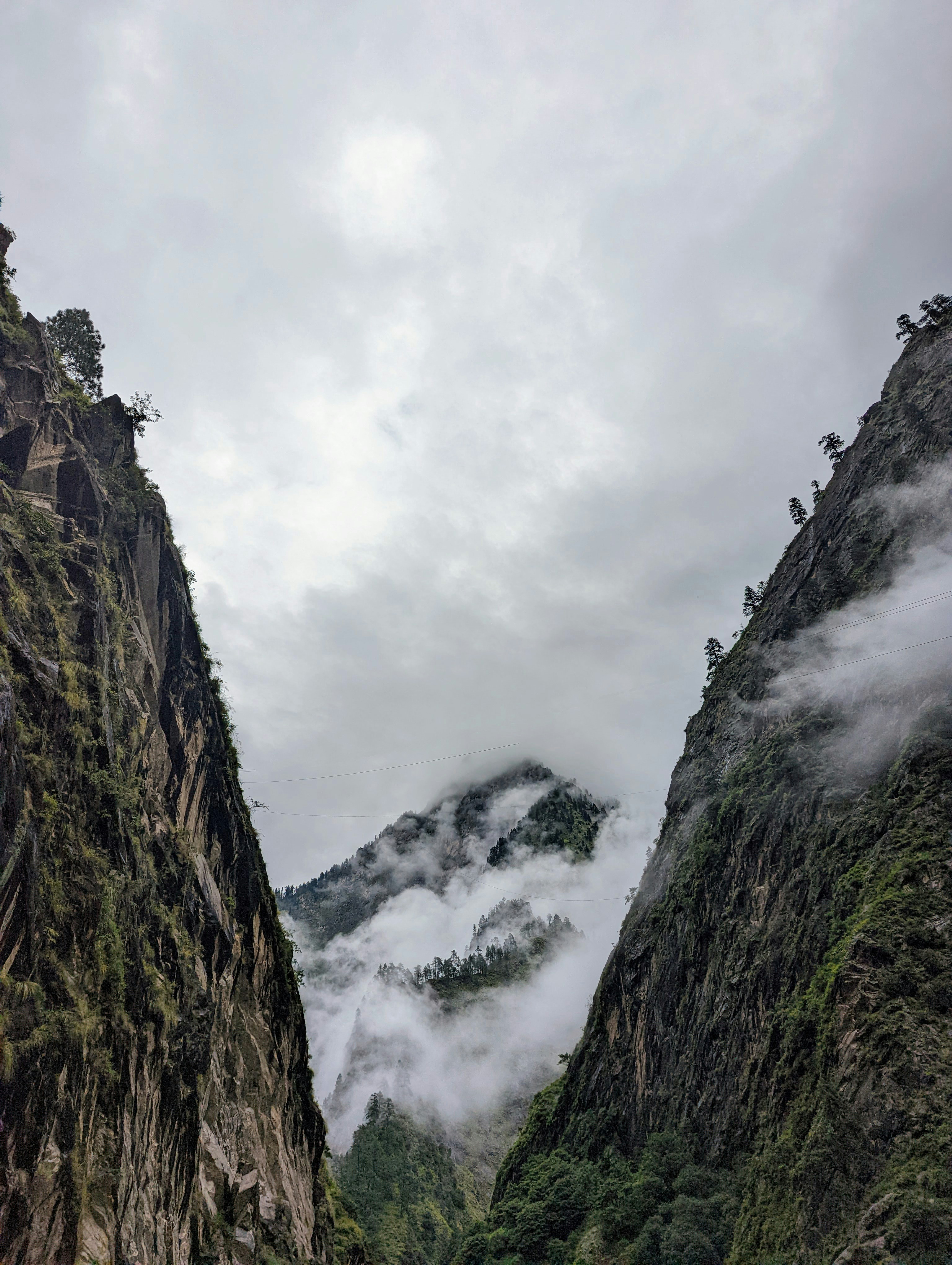 Mist-Clad Gorge Between Towering Peaks